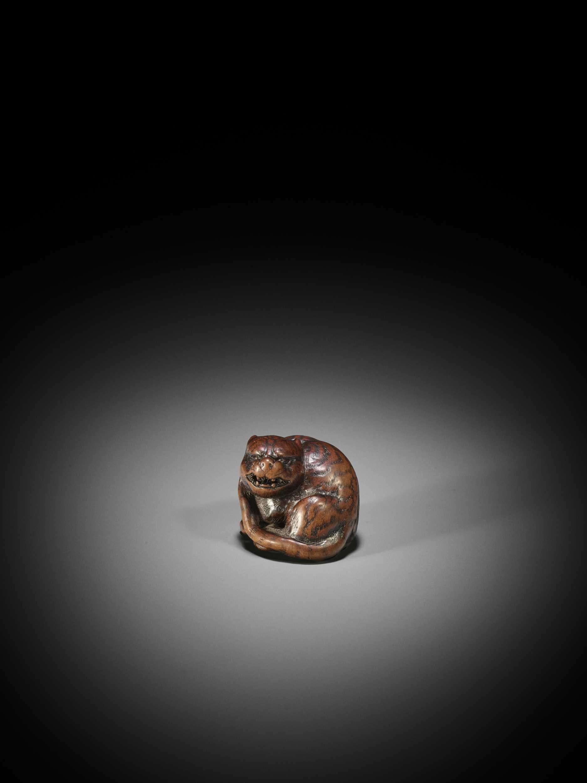 Lot 137 - MASANAO: A WOOD NETSUKE OF A SNARLING TIGER