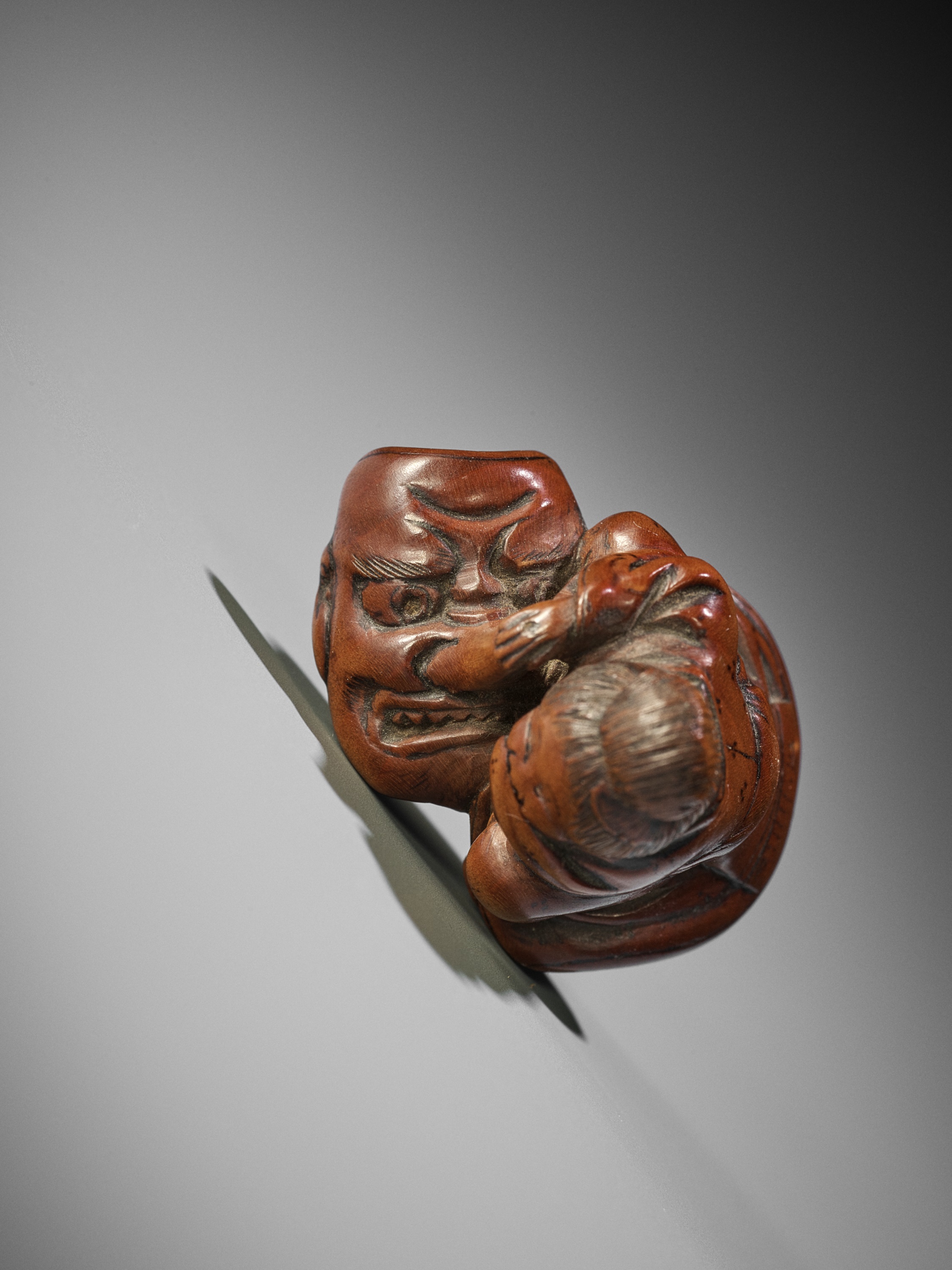 Lot 157 - KASHUN: A WOOD SHUNGA NETSUKE OF OKAME