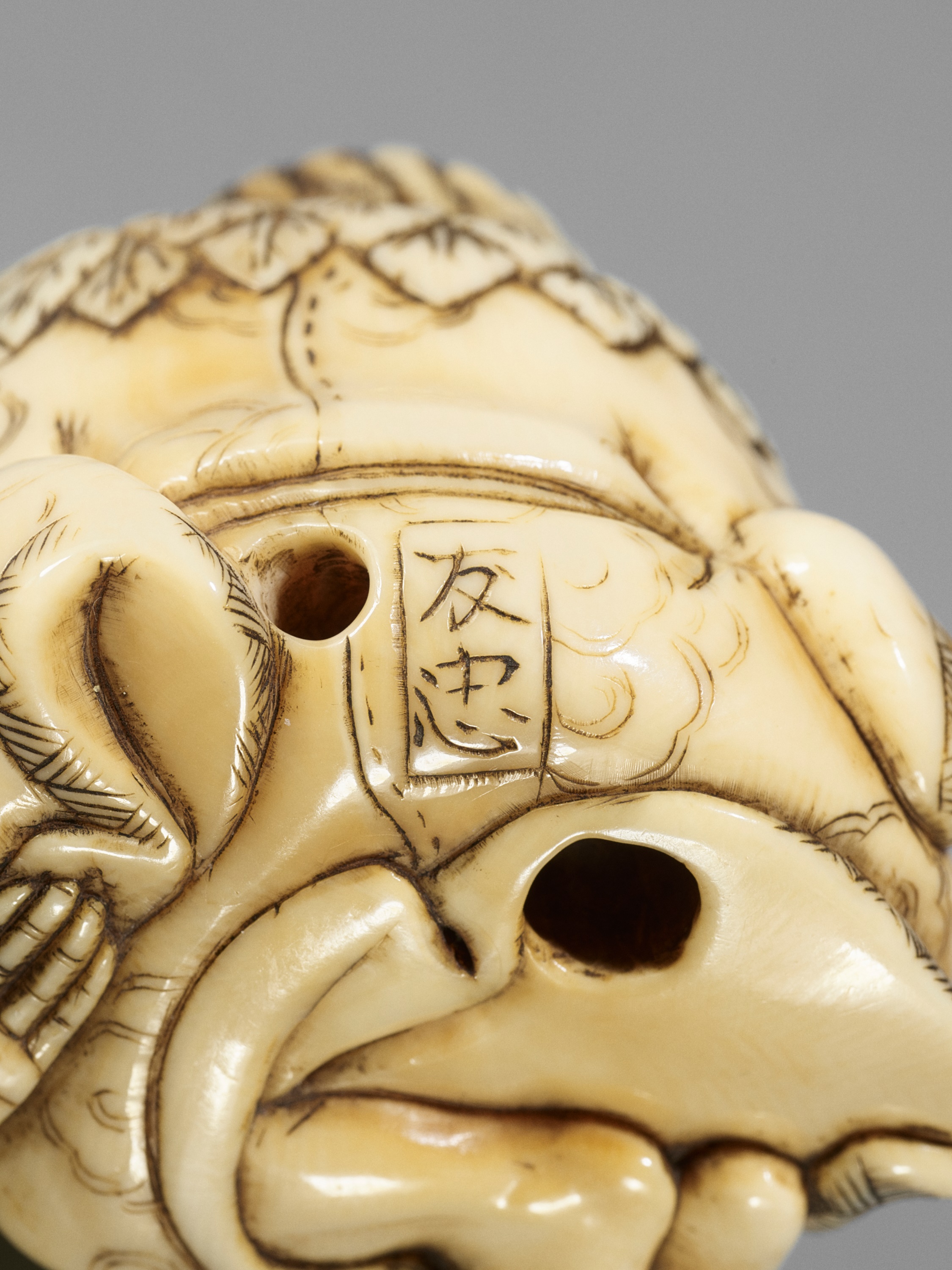 Lot 2 - TOMOTADA: A RARE AND IMPORTANT IVORY NETSUKE