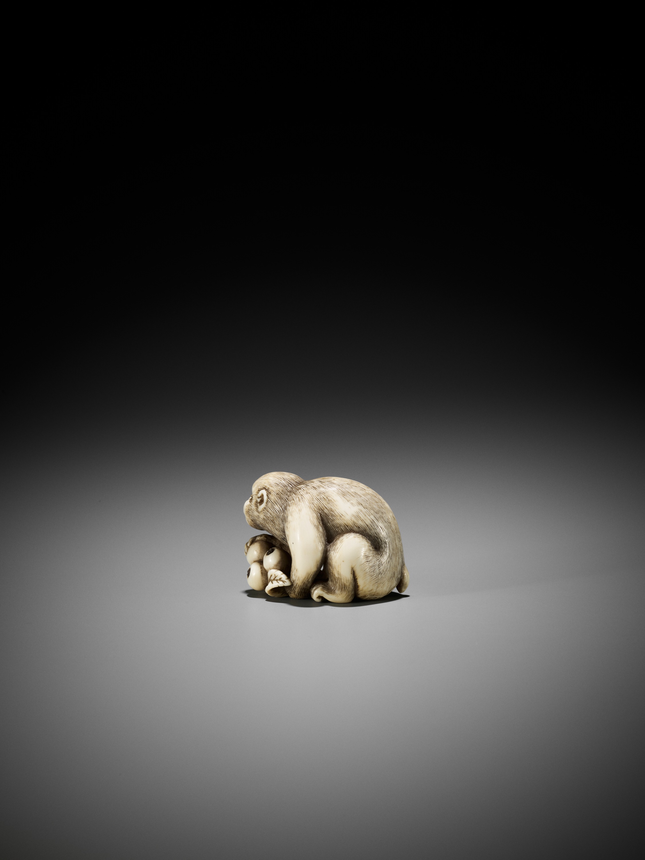 Lot 46 - OKATORI: A FINE IVORY NETSUKE OF A MONKEY