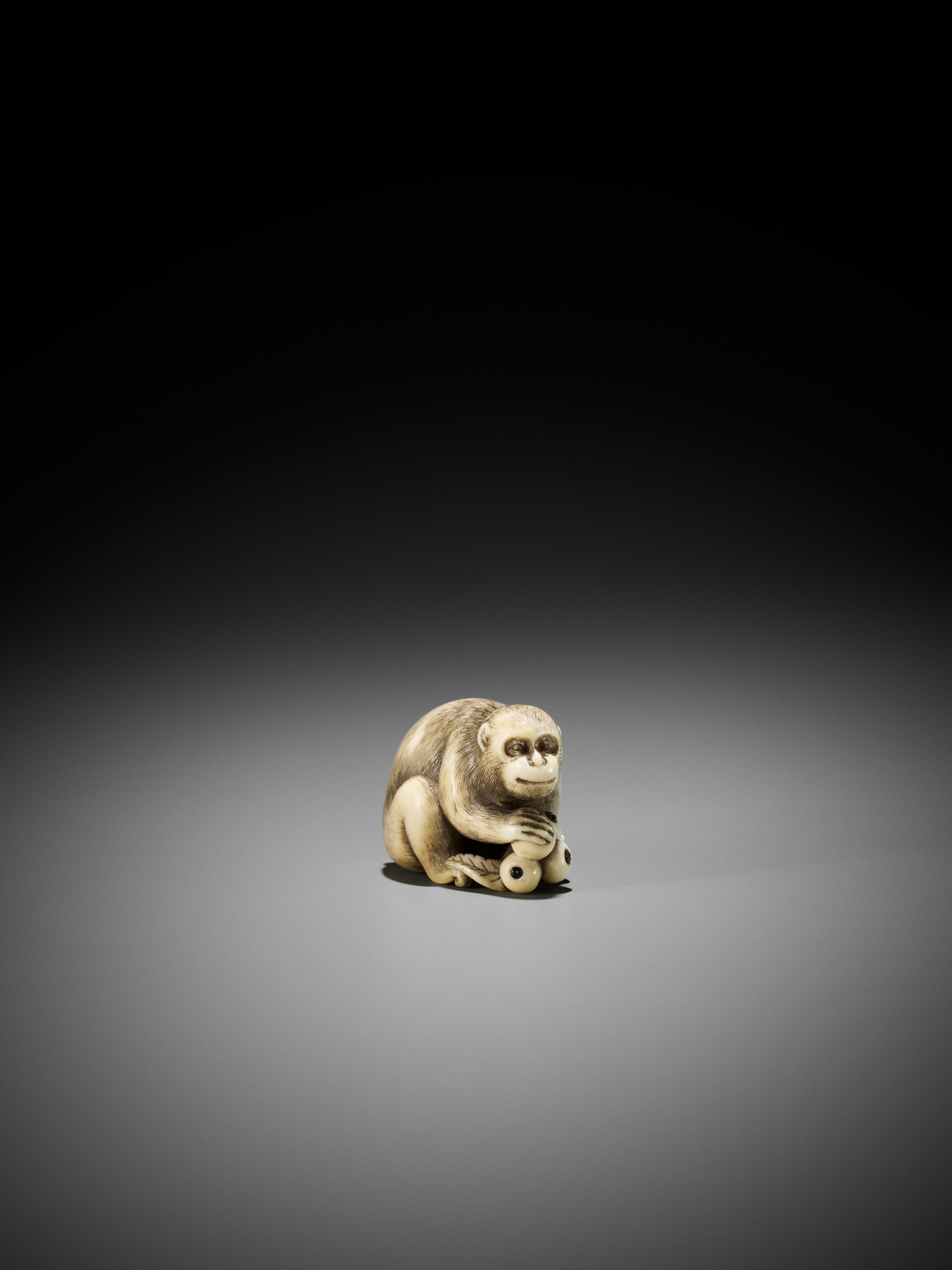Lot 46 - OKATORI: A FINE IVORY NETSUKE OF A MONKEY