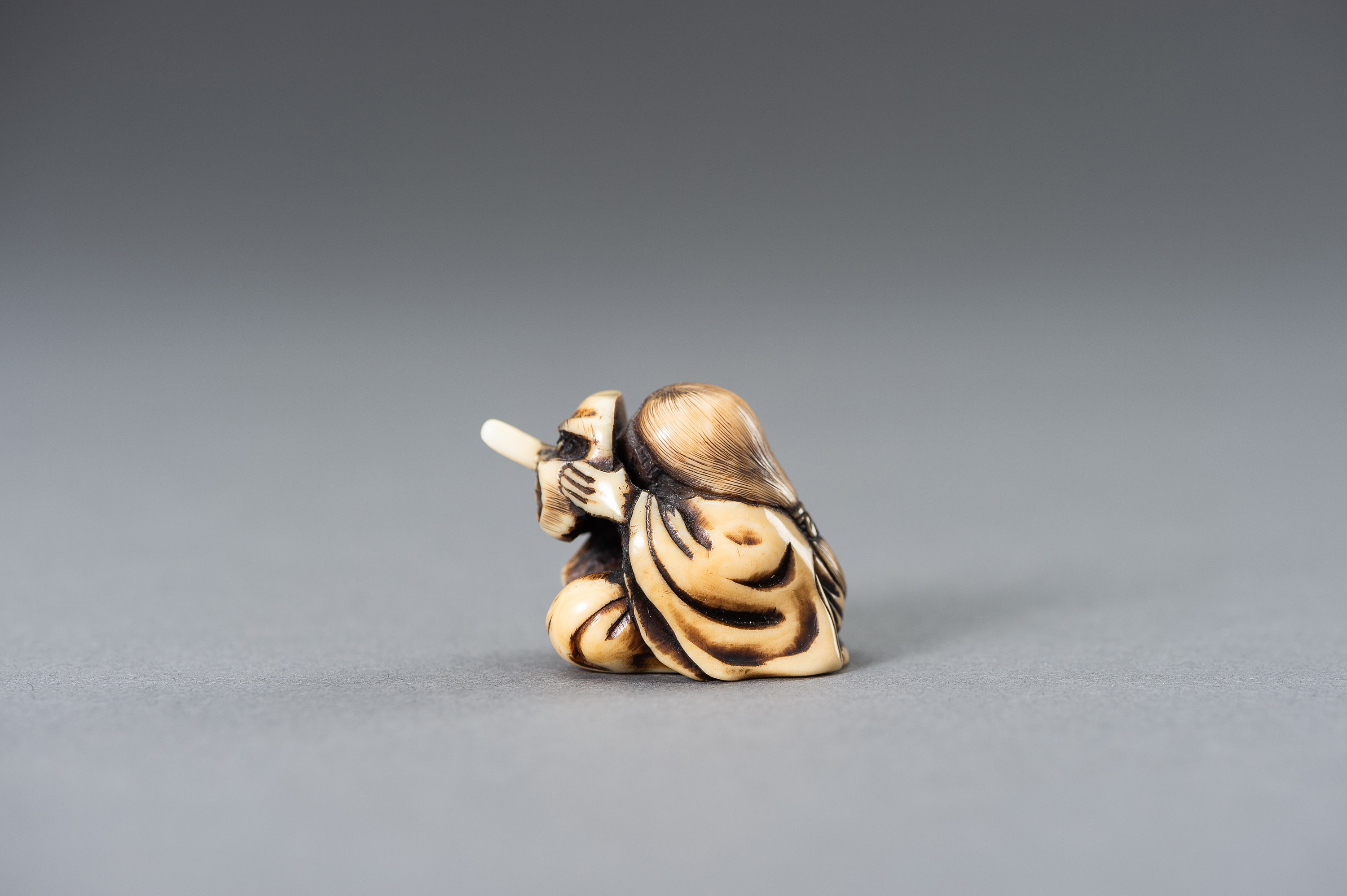 Lot 483 - MASAMITSU: A MARINE IVORY NETSUKE OF OKAME