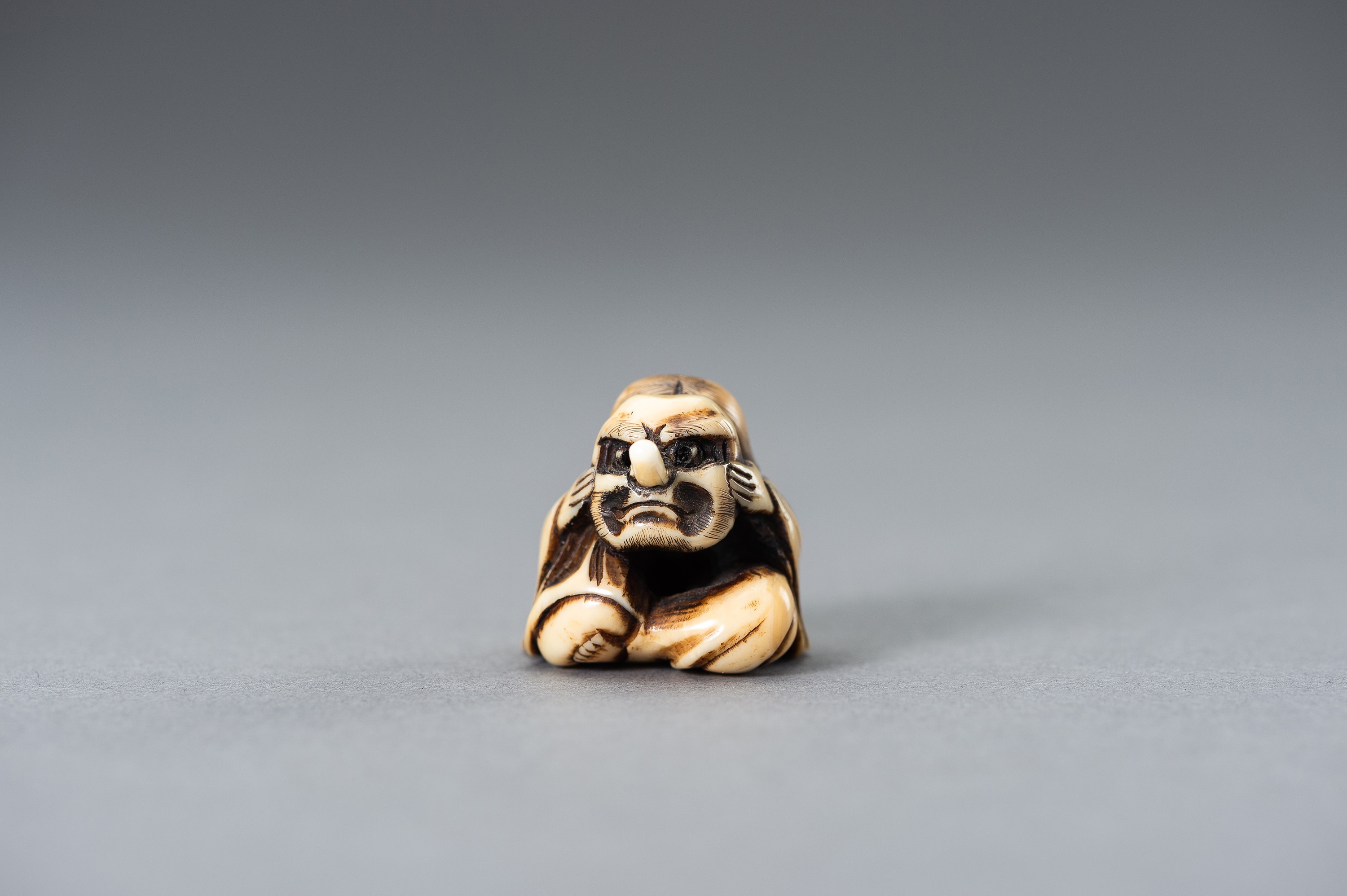 Lot 483 - MASAMITSU: A MARINE IVORY NETSUKE OF OKAME