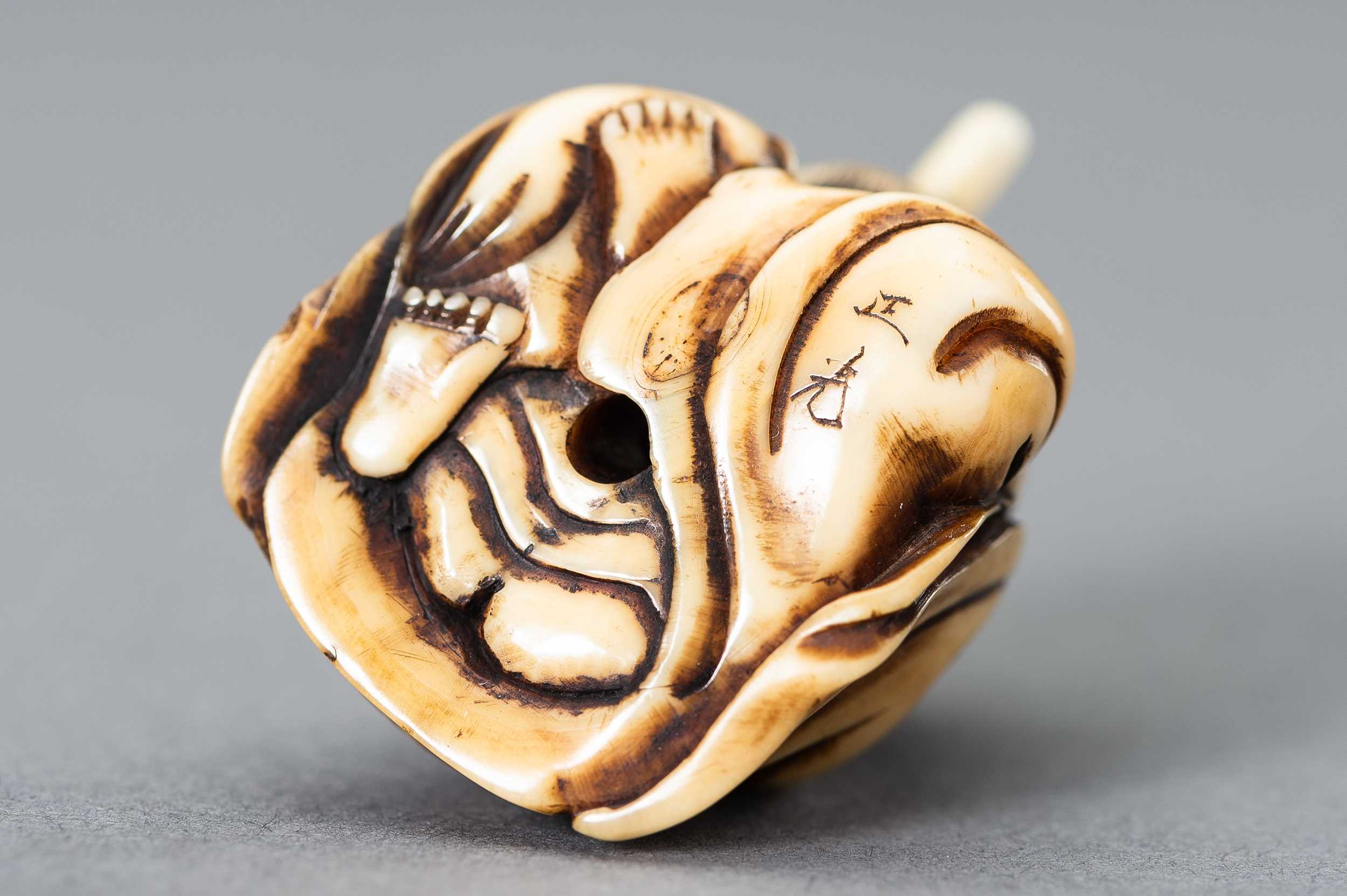 Lot 483 - MASAMITSU: A MARINE IVORY NETSUKE OF OKAME