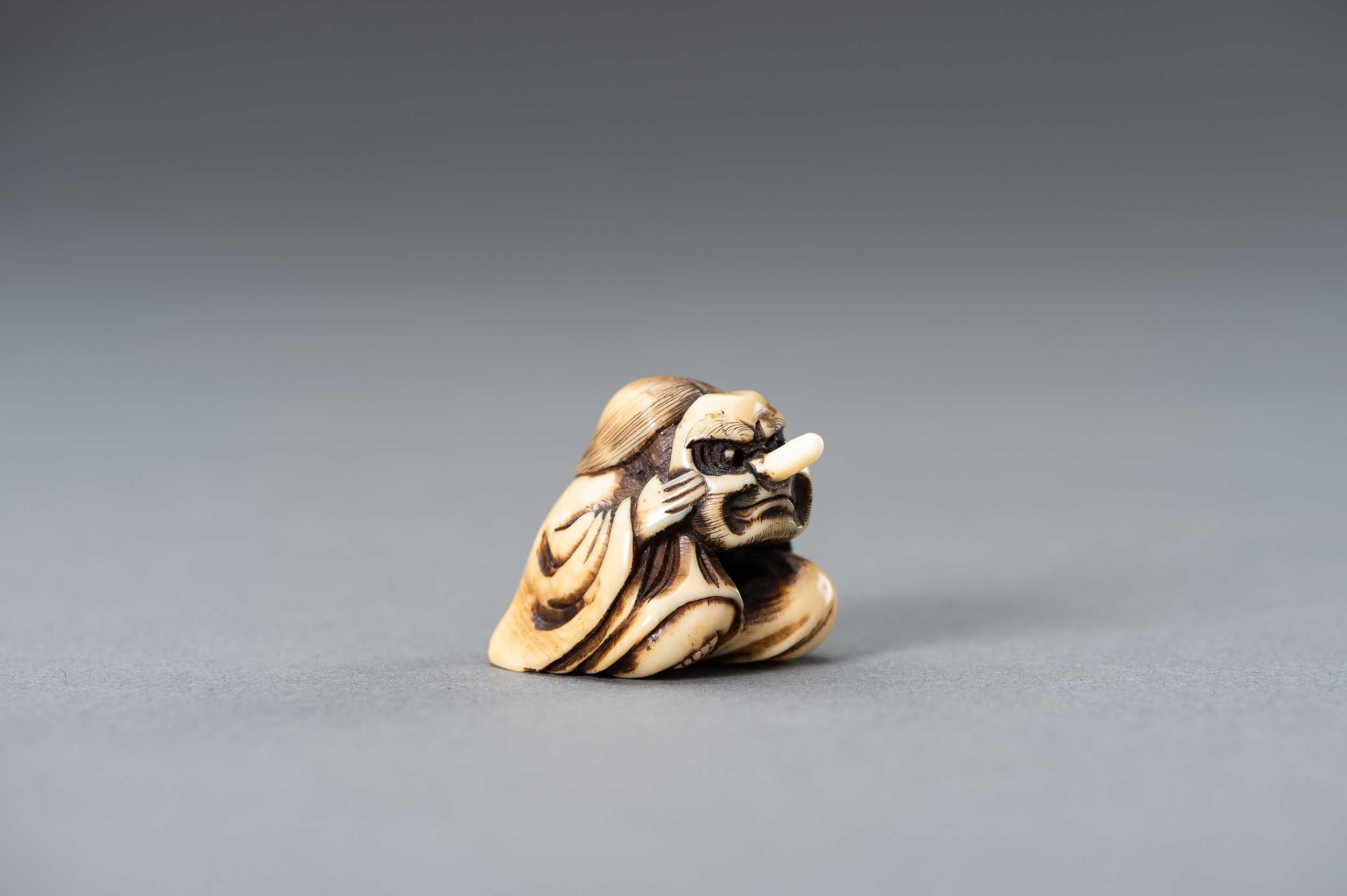 Lot 483 - MASAMITSU: A MARINE IVORY NETSUKE OF OKAME