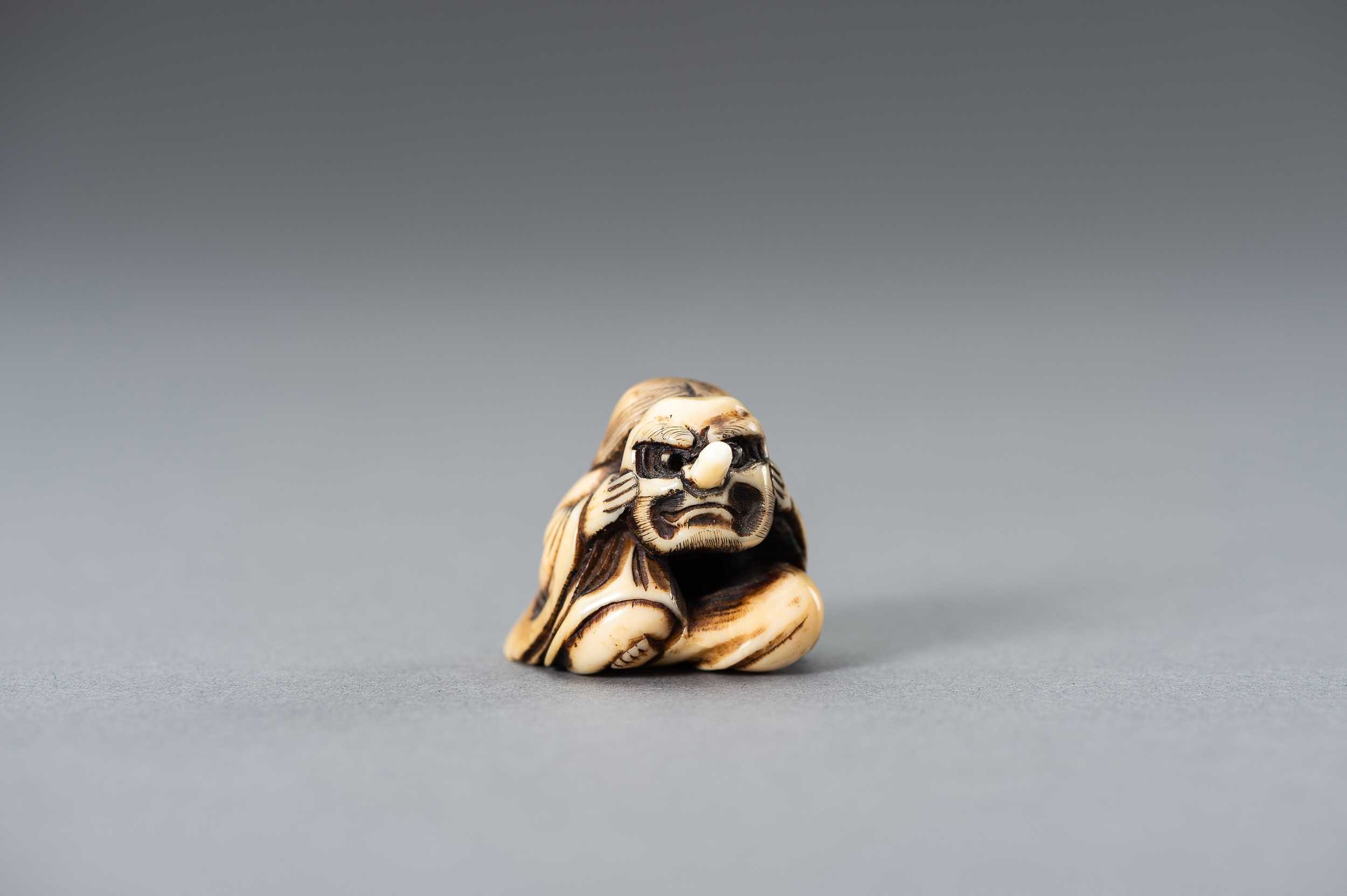 Lot 483 - MASAMITSU: A MARINE IVORY NETSUKE OF OKAME