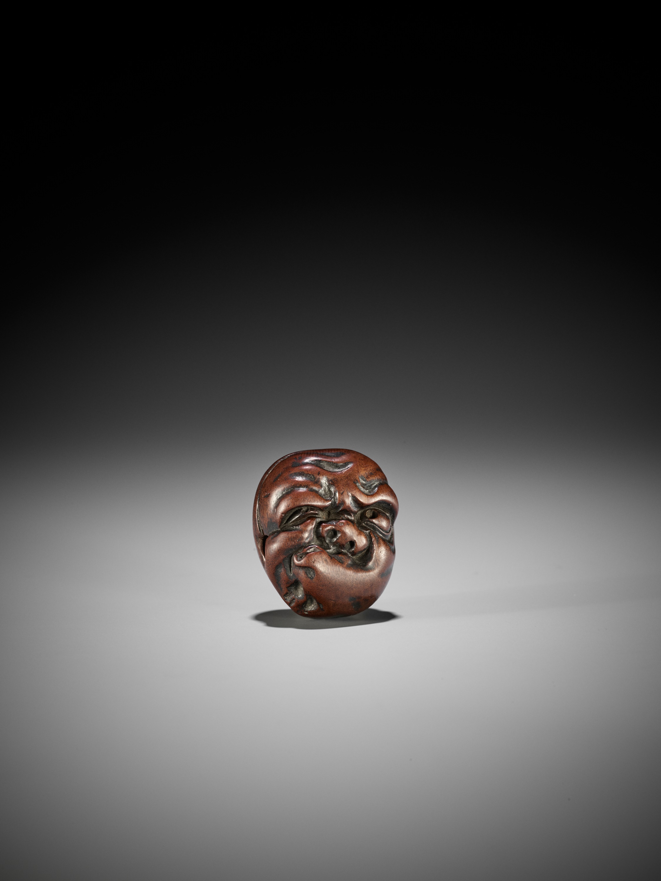 Lot 82 - ITTAN: A RARE WOOD SHUNGA MASK NETSUKE OF