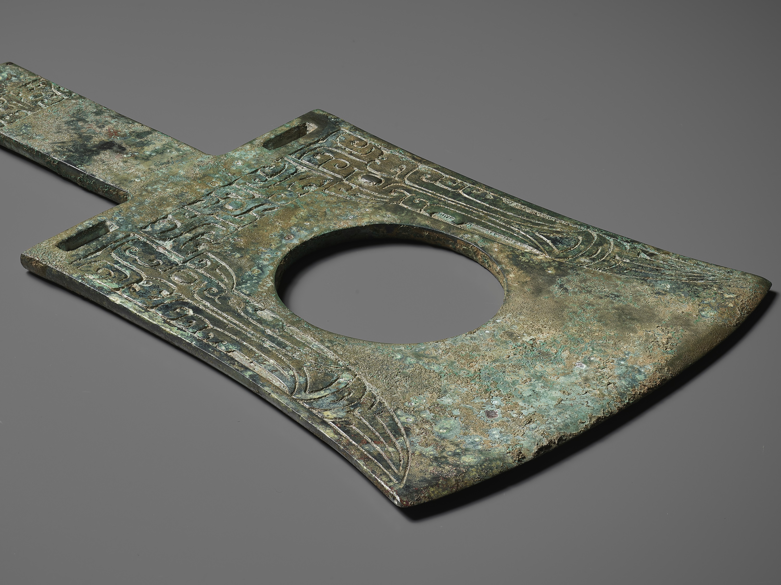 Lot 1 - A RARE AND IMPORTANT BRONZE RITUAL AXE-HEAD,