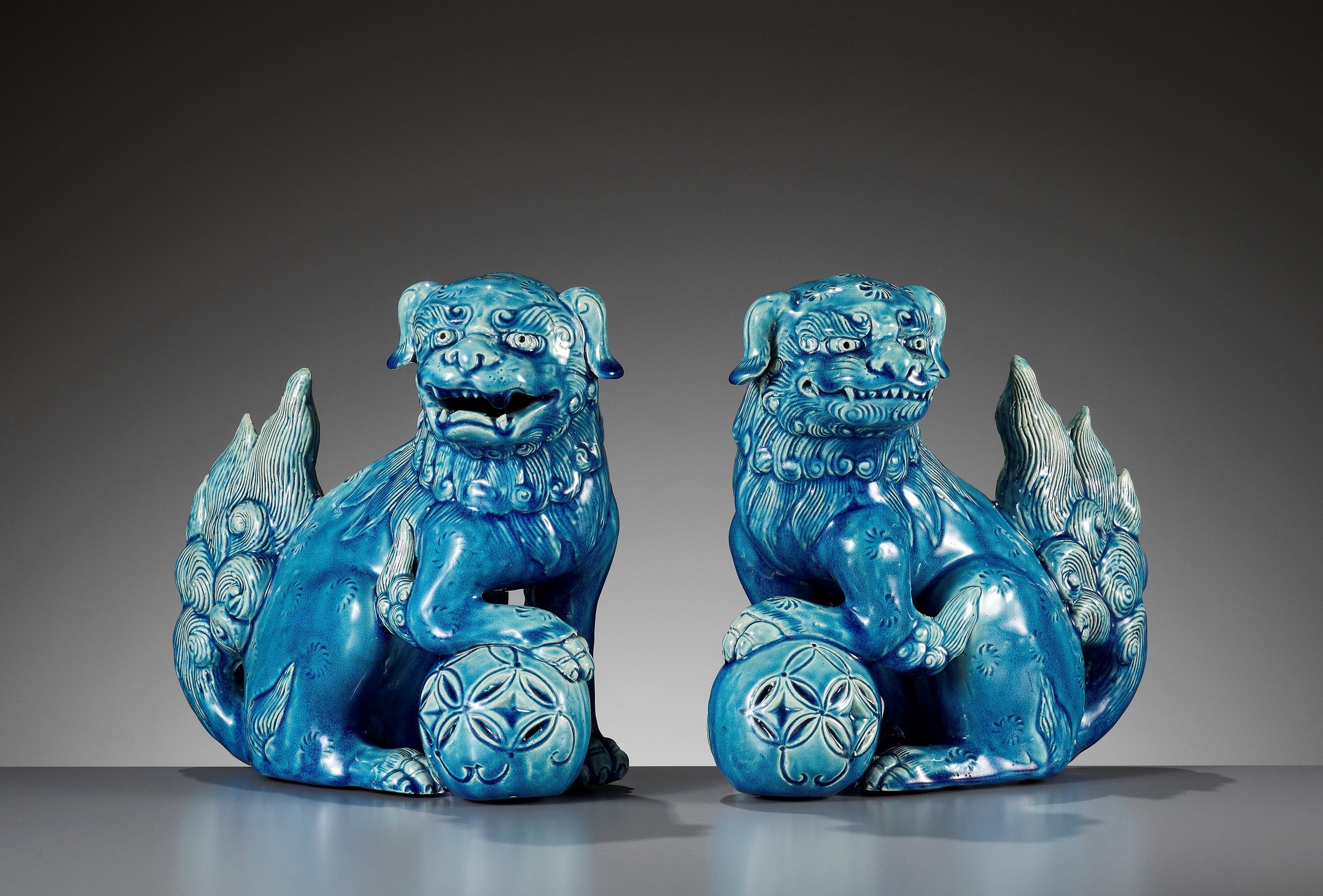 Lot 433 - A PAIR OF TURQUOISE GLAZED BUDDHIST LIONS,