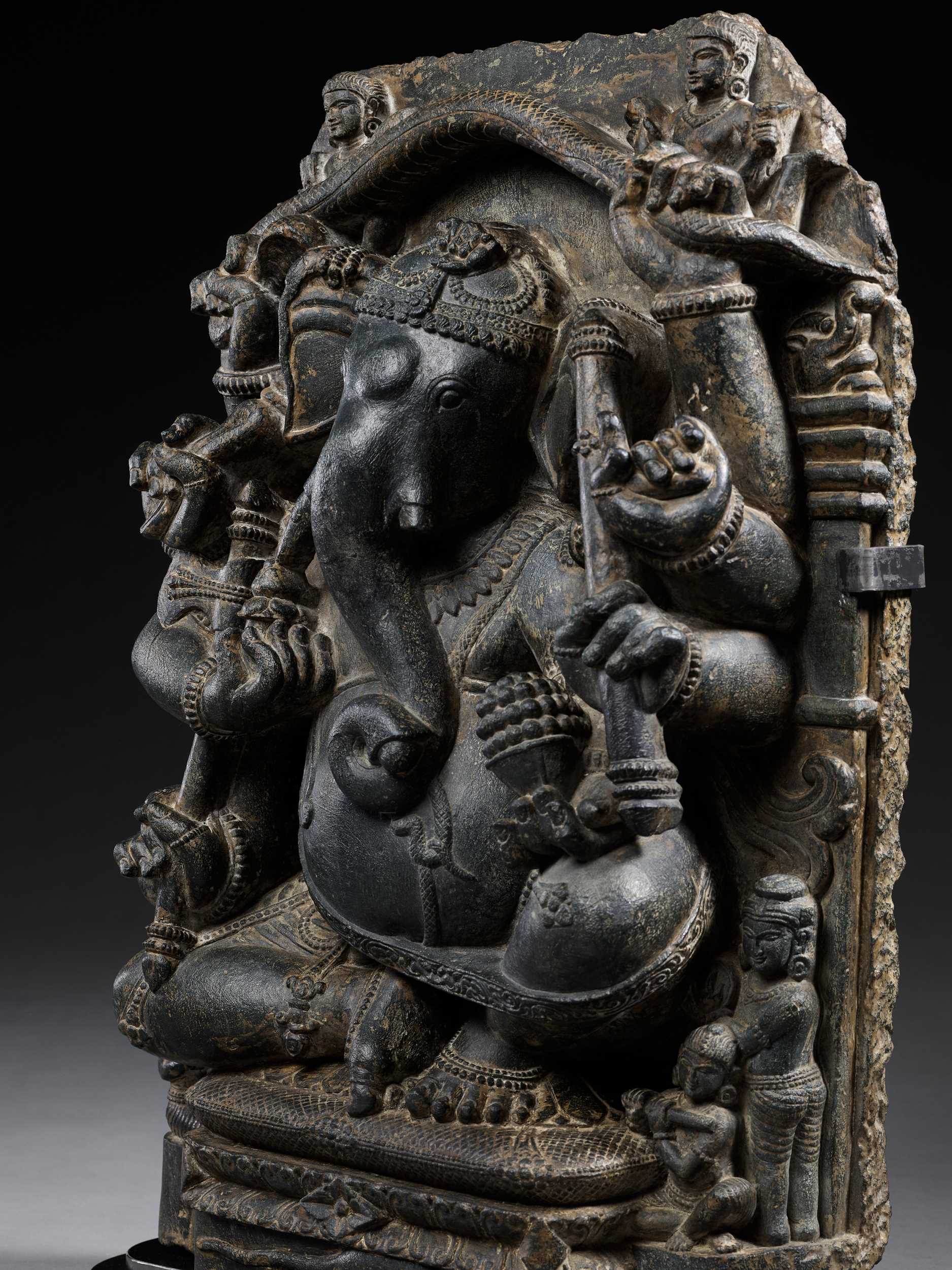 Lot 251 - A BLACK SCHIST FIGURE OF GANESHA WITH A