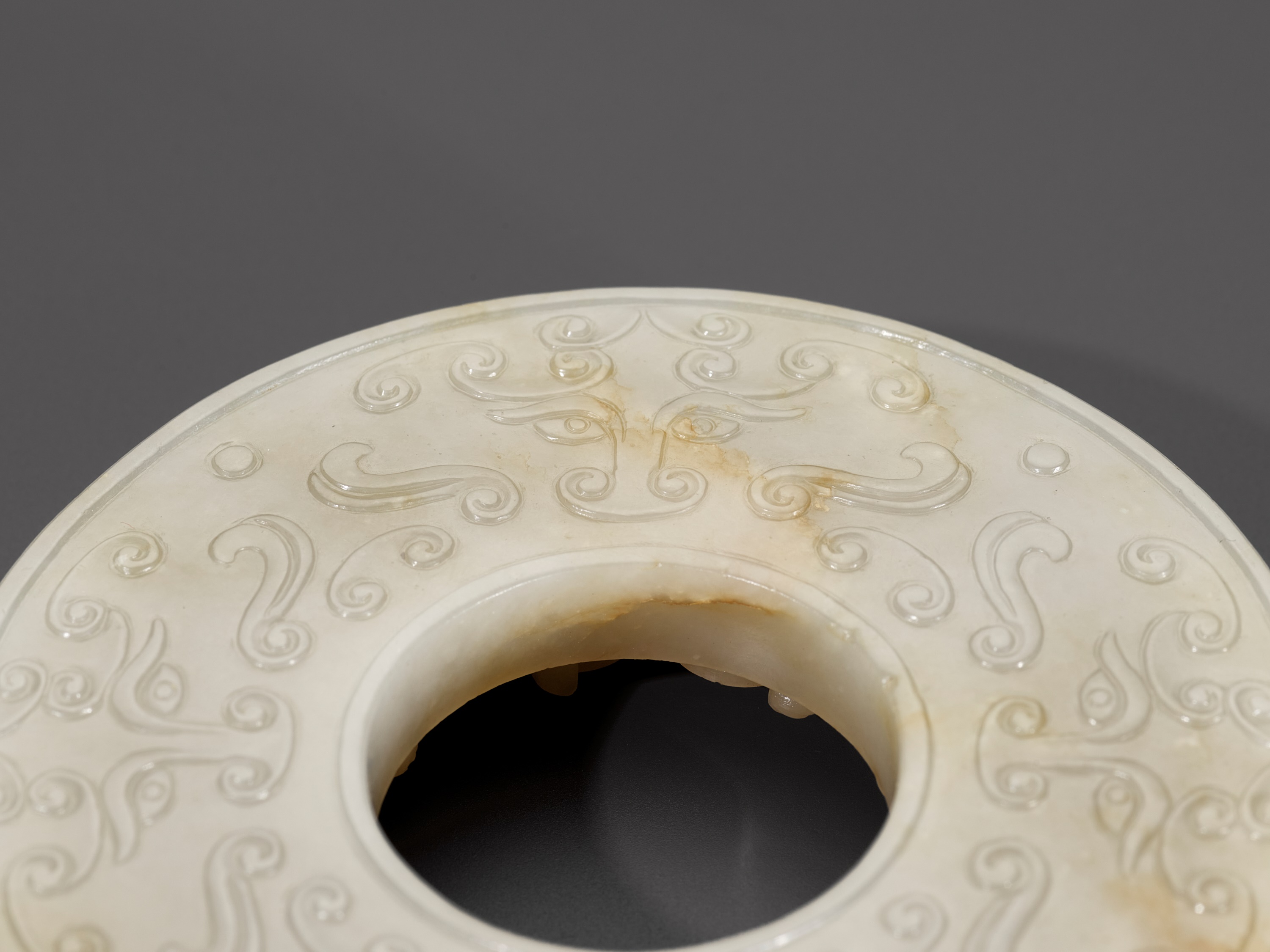 Lot 350 - A PALE CELADON AND RUSSET JADE ‘CHILONG’