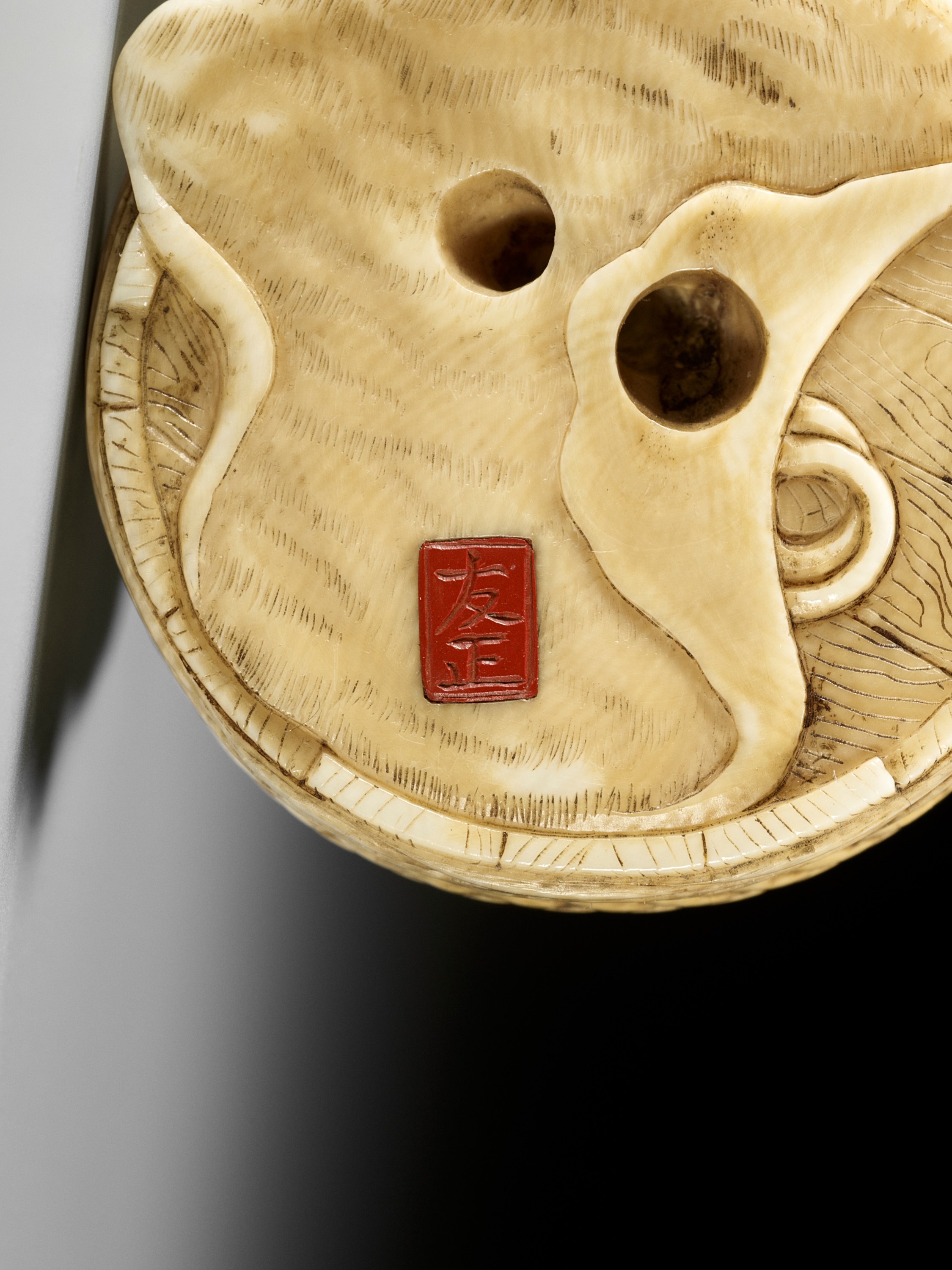 Lot 261 - TOMOMASA: AN IVORY NETSUKE OF A BATHING ONI