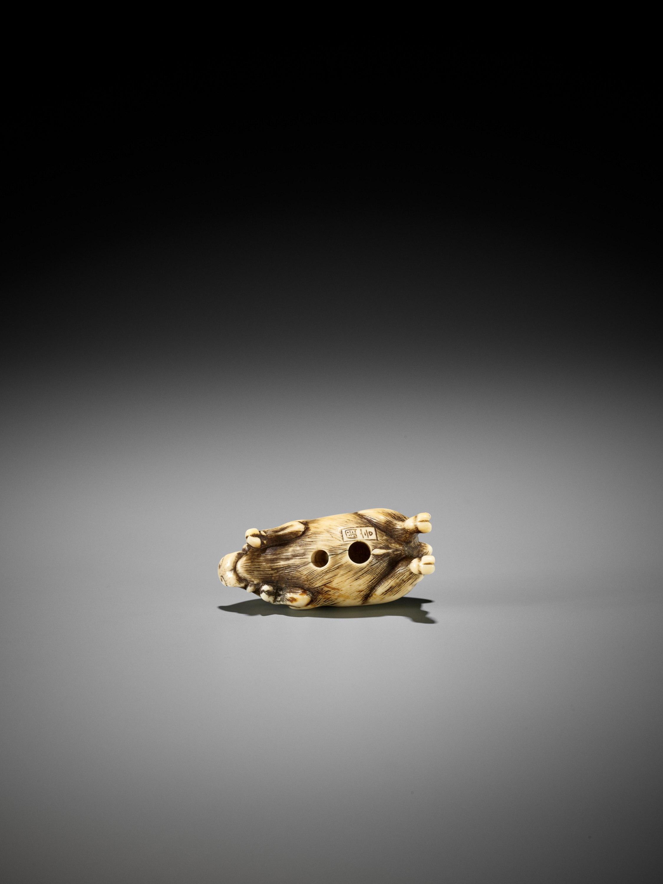 Lot 19 - OKAKOTO: A RARE IVORY NETSUKE OF A RUNNING