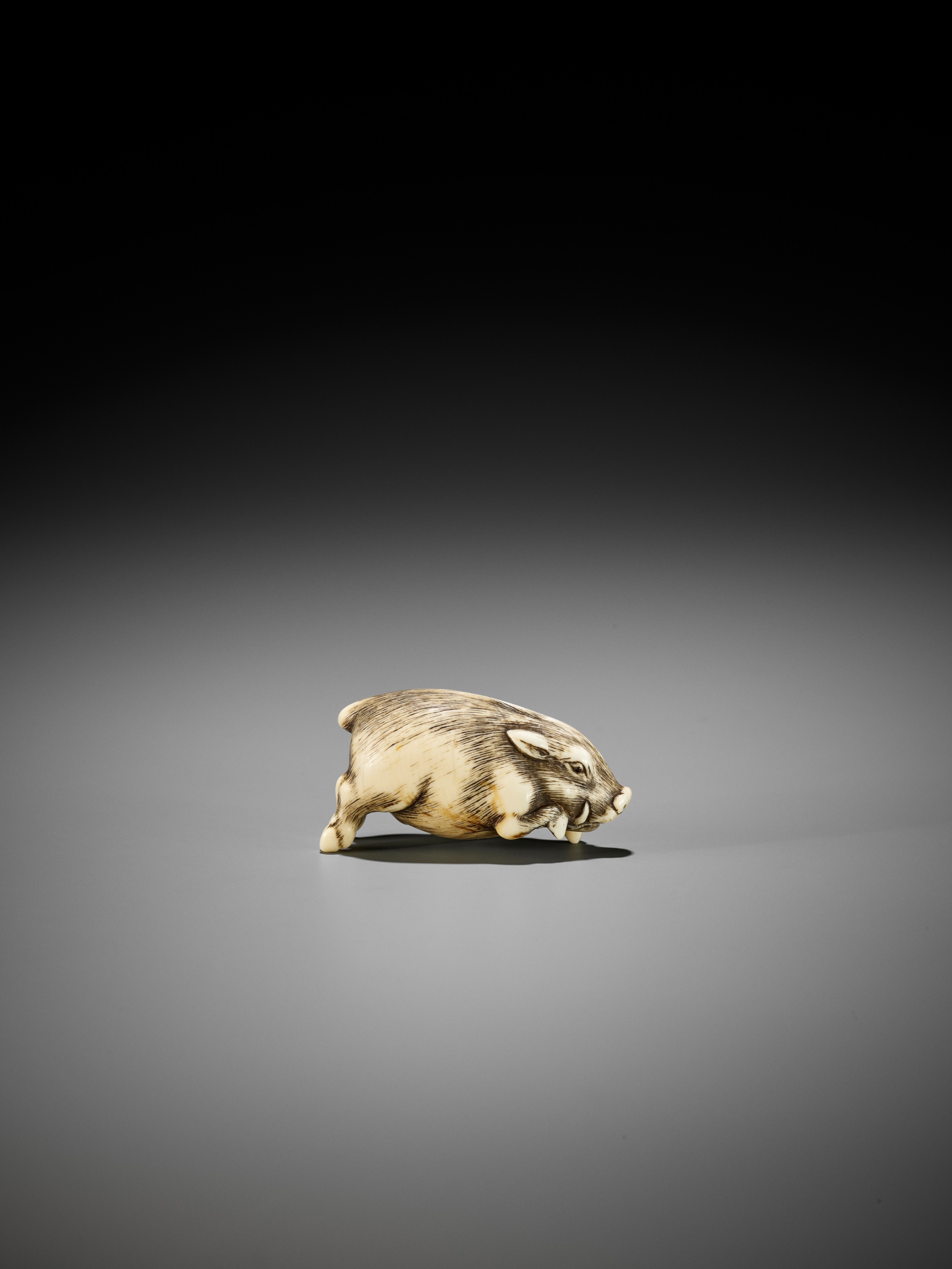 Lot 19 - OKAKOTO: A RARE IVORY NETSUKE OF A RUNNING