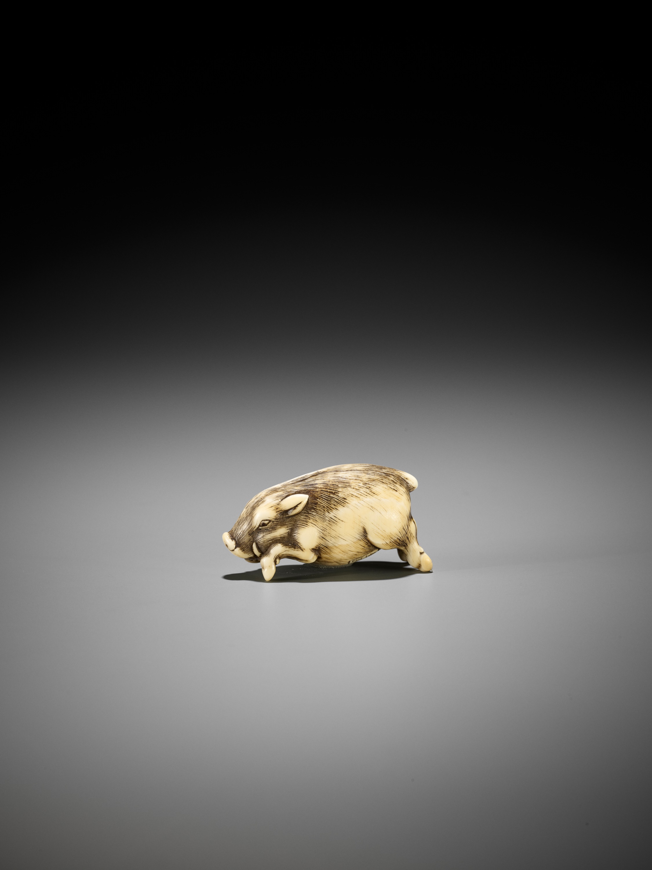 Lot 19 - OKAKOTO: A RARE IVORY NETSUKE OF A RUNNING