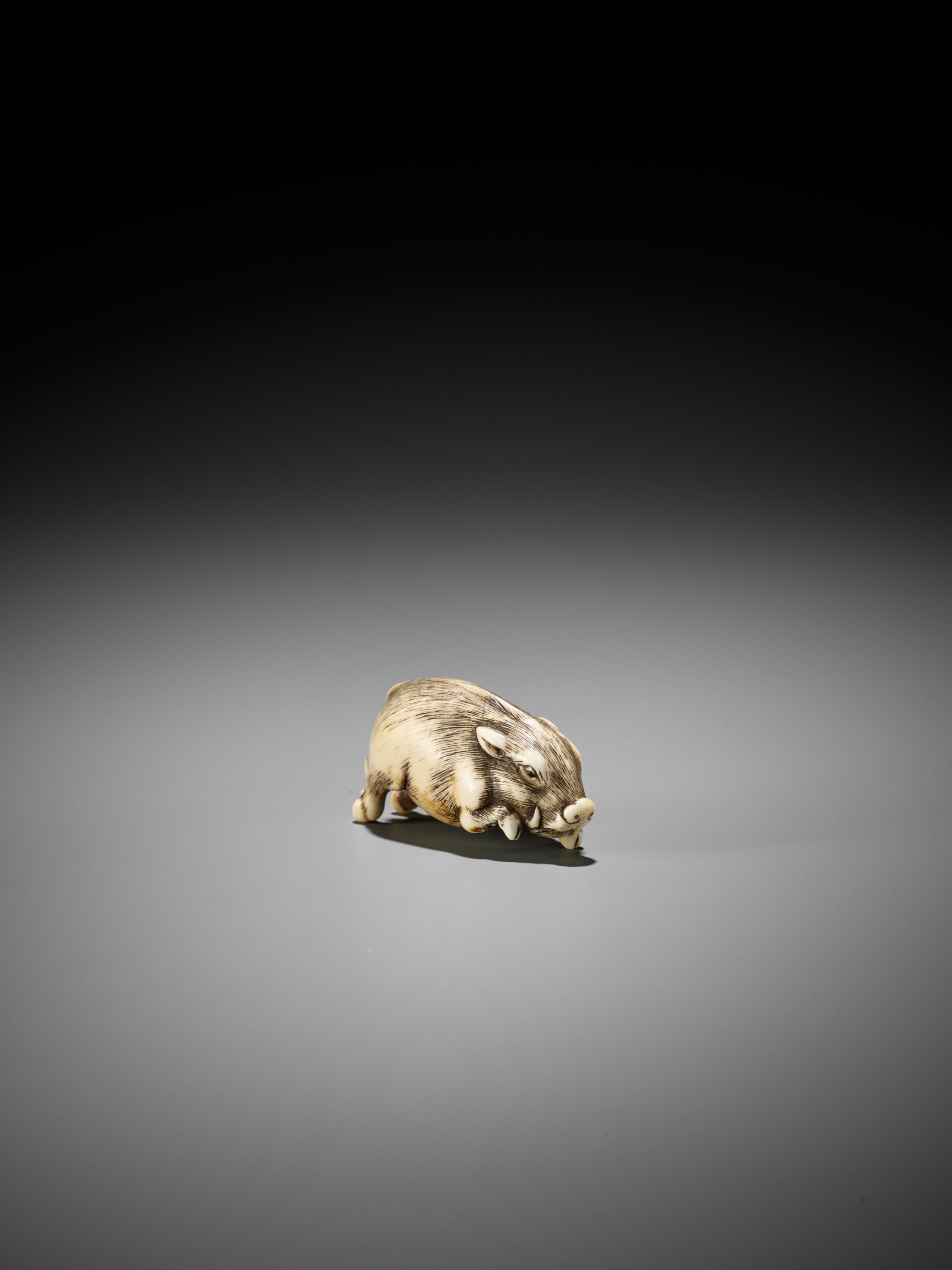 Lot 19 - OKAKOTO: A RARE IVORY NETSUKE OF A RUNNING