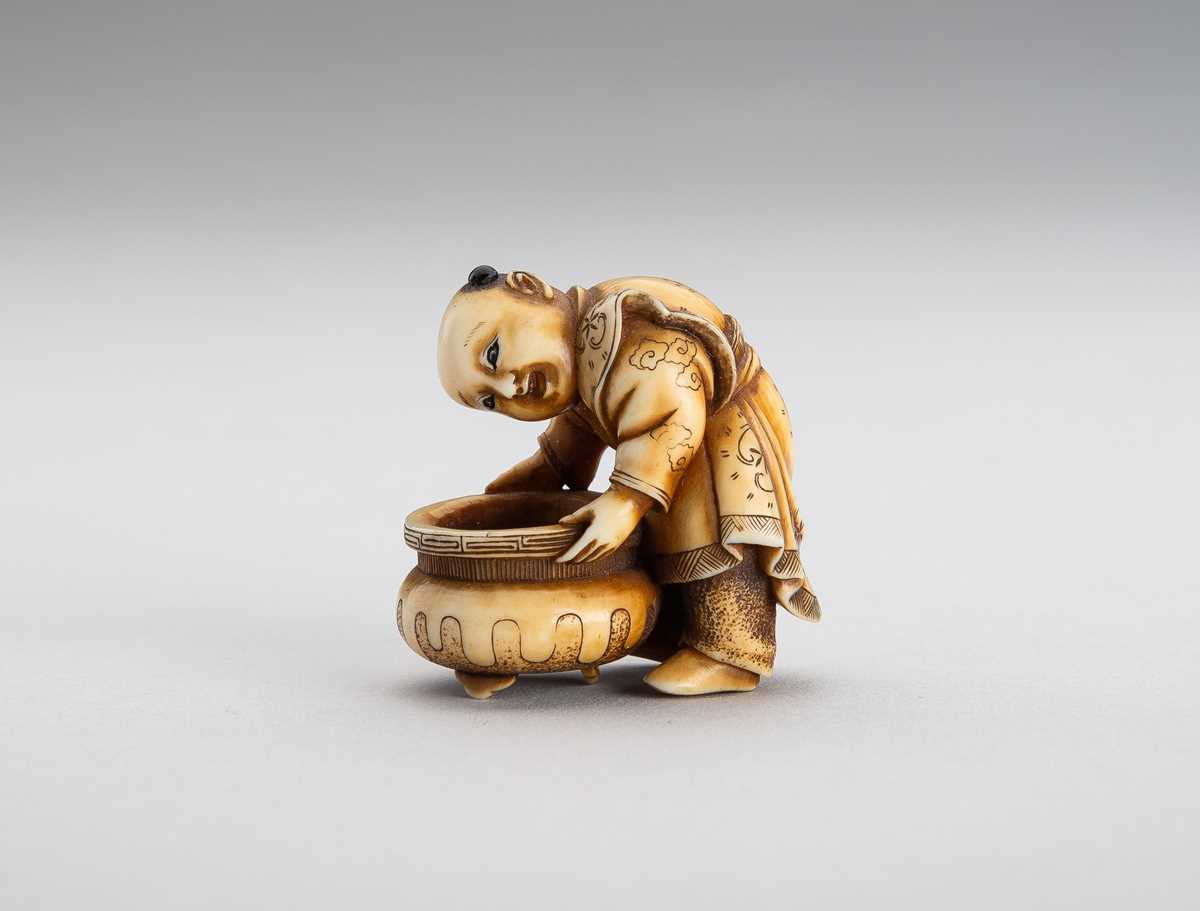 Lot 1507 - KOSHIN: AN IVORY NETSUKE OF A KARAKO WITH