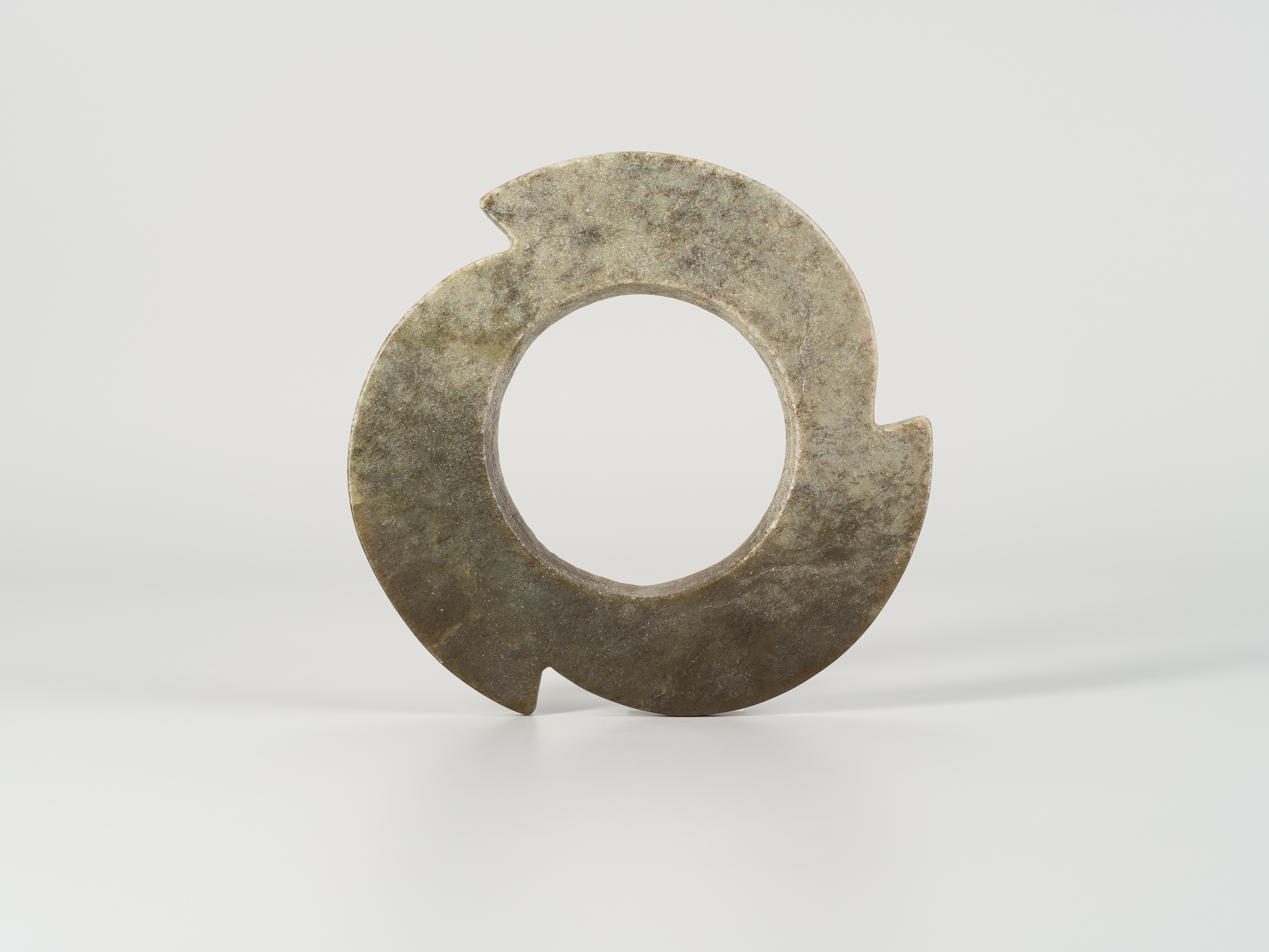 Lot 800 - A JADE NOTCHED DISC, LATE NEOLITHIC PERIOD