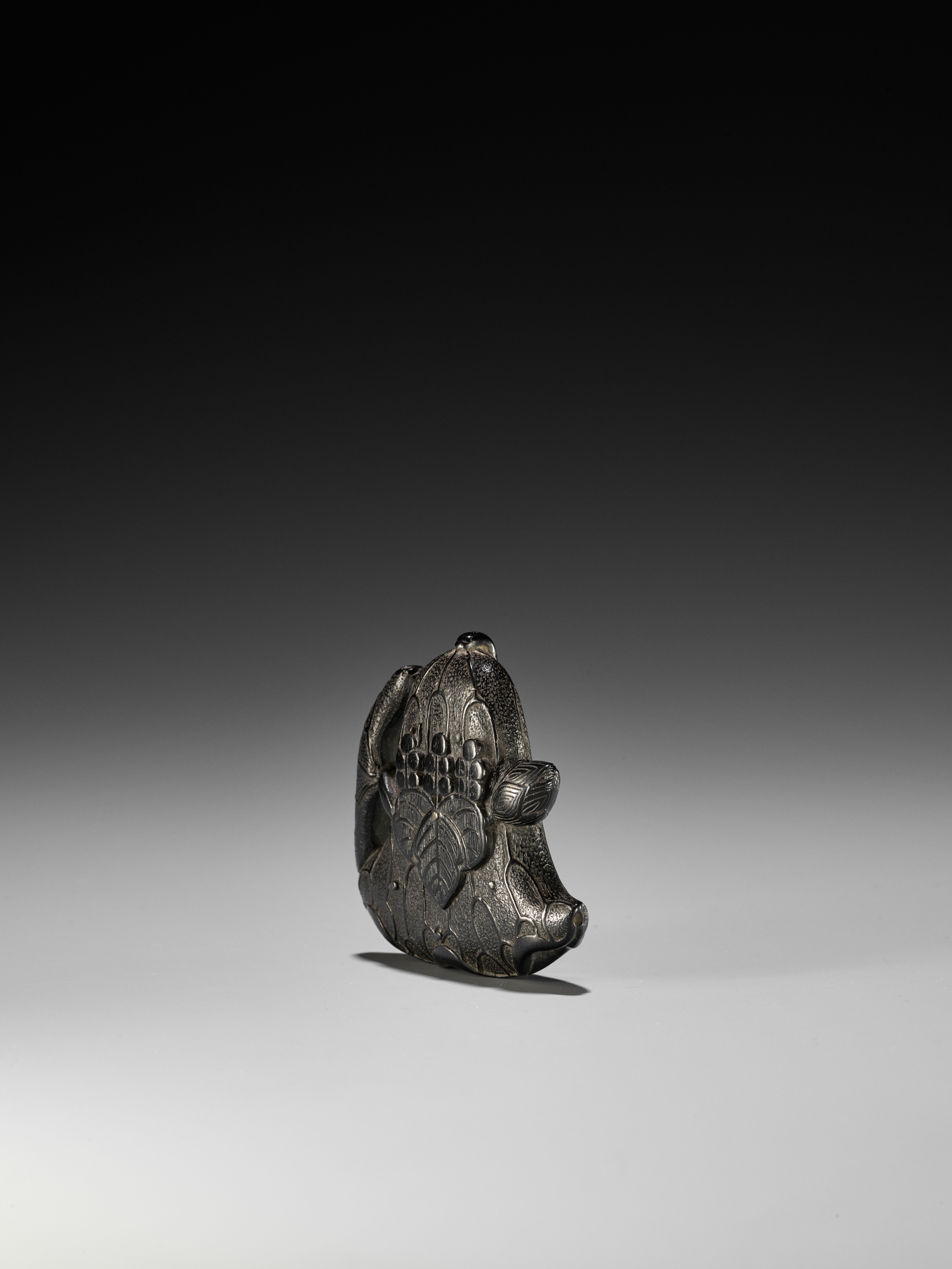 Lot 91 - AN UNUSUAL AND LARGE EBONY NETSUKE WITH LOTUS