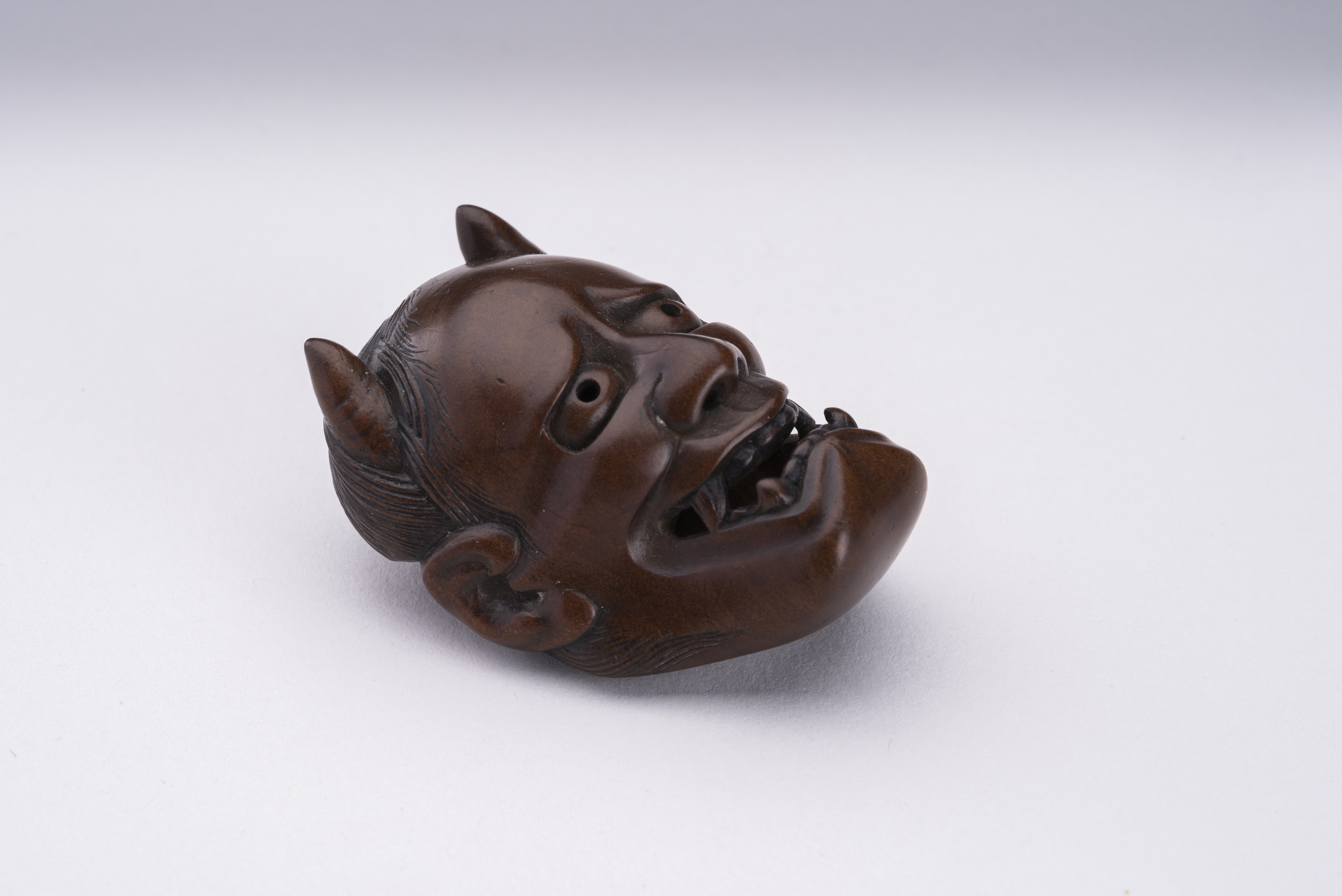 Lot 1510 - NAOAKI: A BOXWOOD MASK NETSUKE OF HANNYA