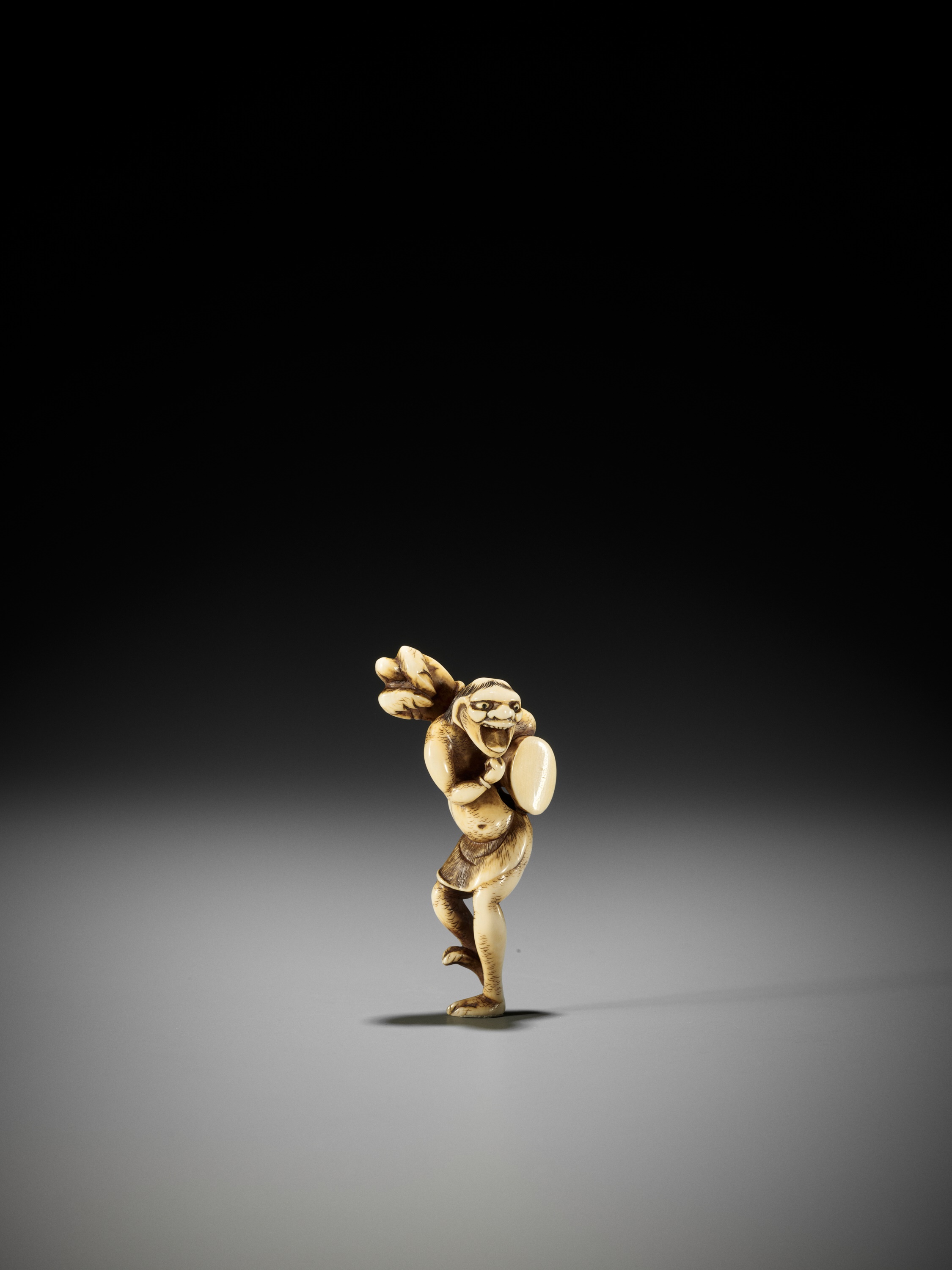 Lot 66 - OTOMAN: A SUPERB IVORY NETSUKE OF AN ONI WITH