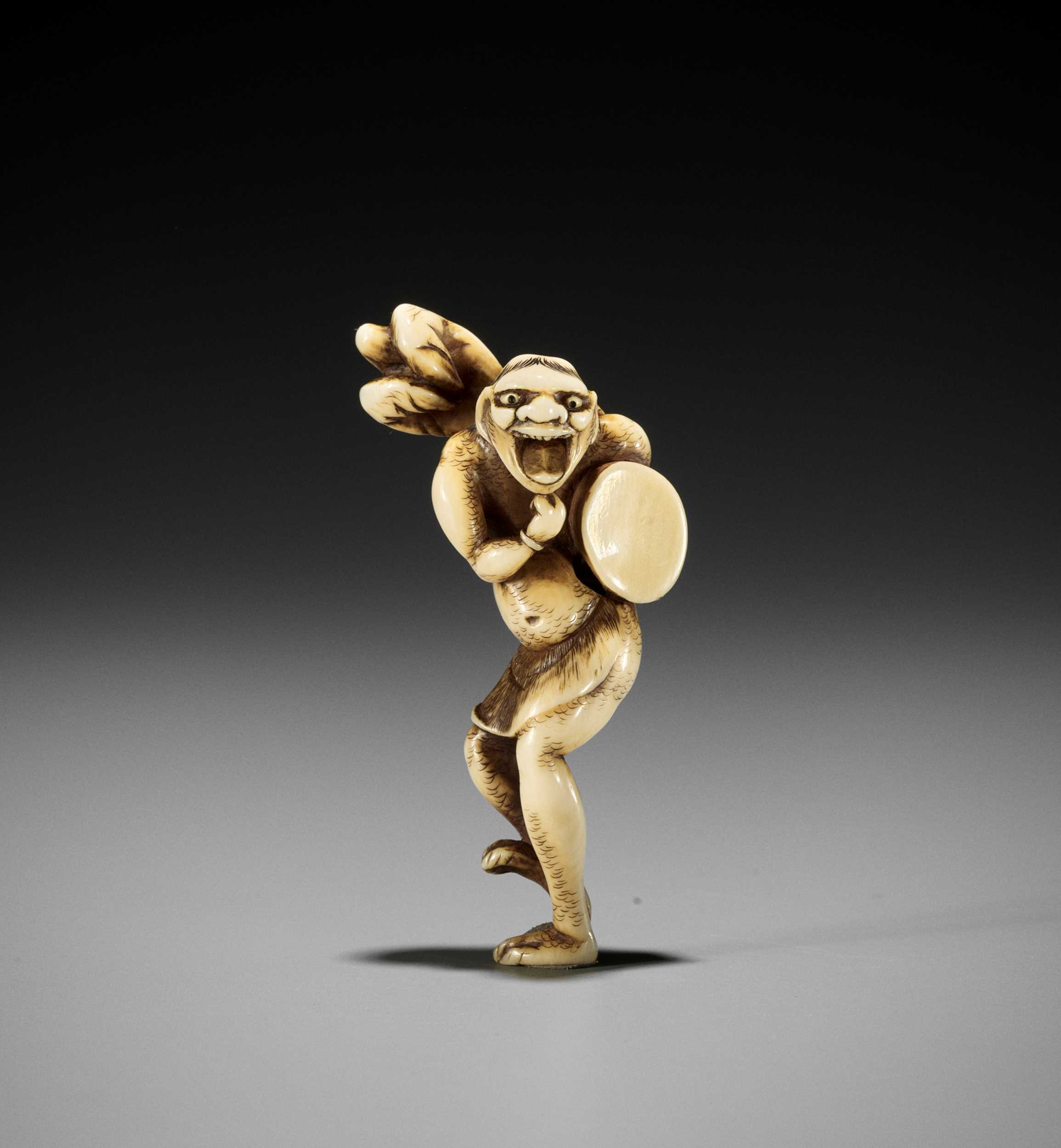 Lot 66 - OTOMAN: A SUPERB IVORY NETSUKE OF AN ONI WITH