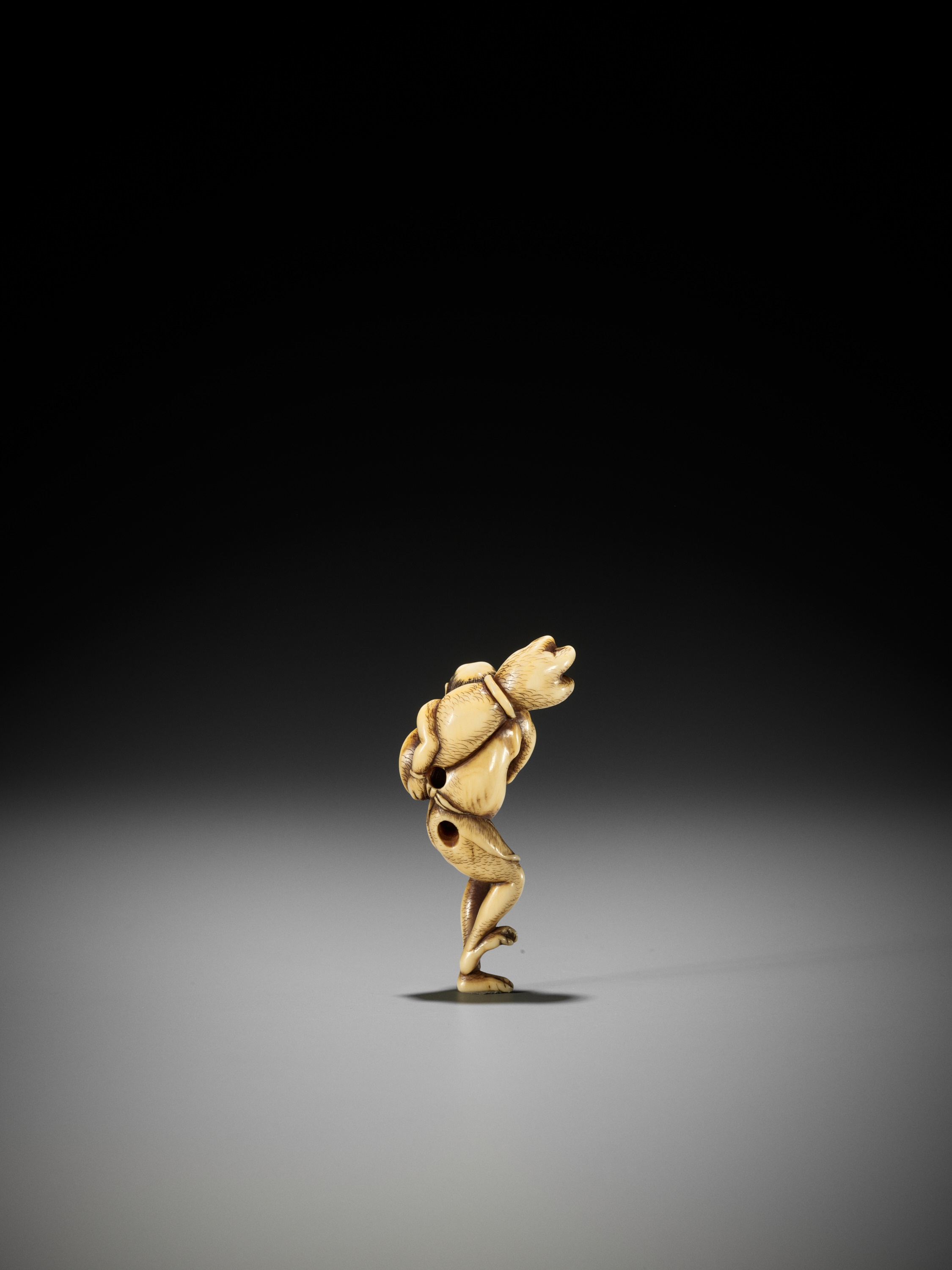 Lot 66 - OTOMAN: A SUPERB IVORY NETSUKE OF AN ONI WITH