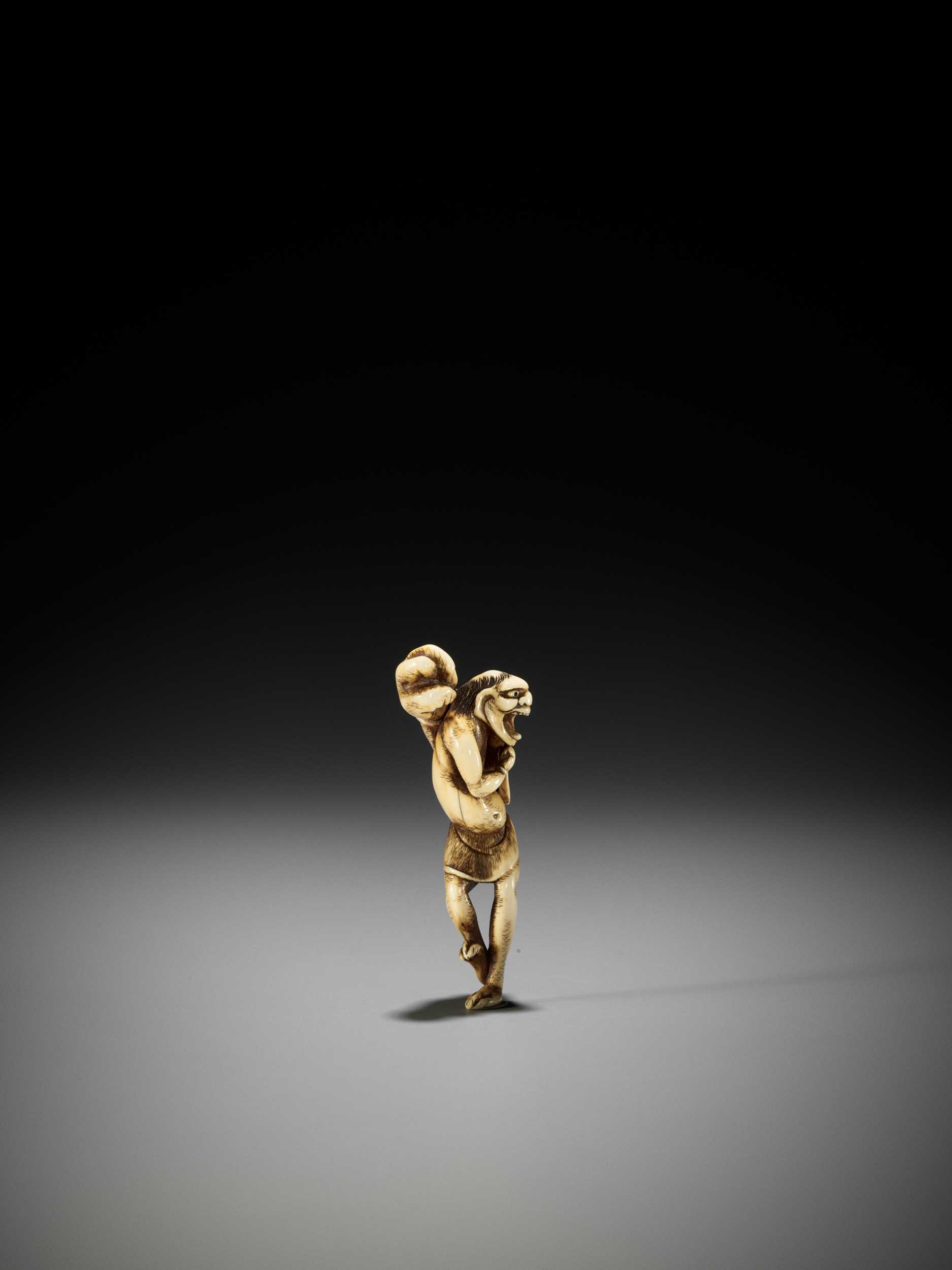Lot 66 - OTOMAN: A SUPERB IVORY NETSUKE OF AN ONI WITH