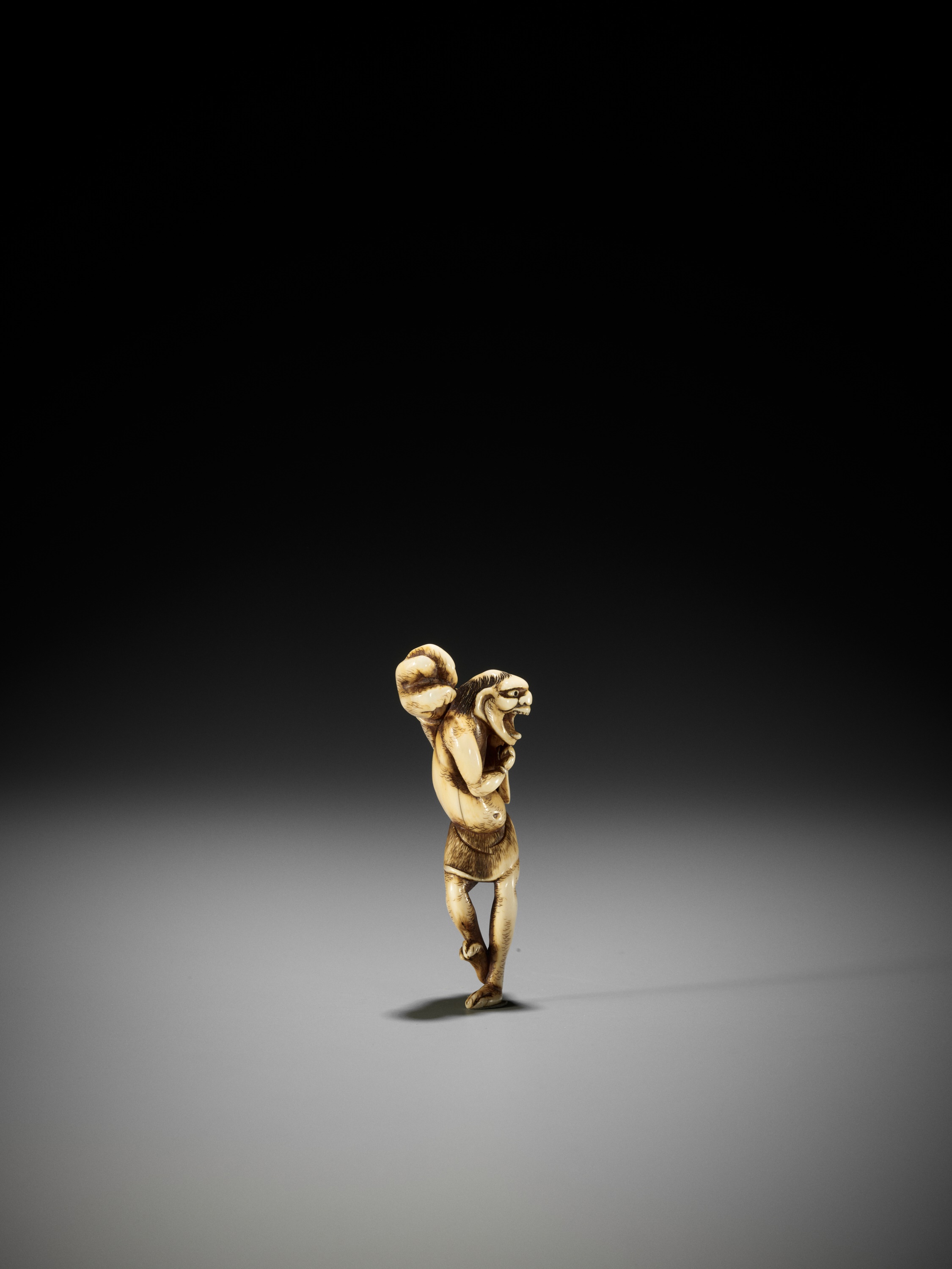 Lot 66 - OTOMAN: A SUPERB IVORY NETSUKE OF AN ONI WITH