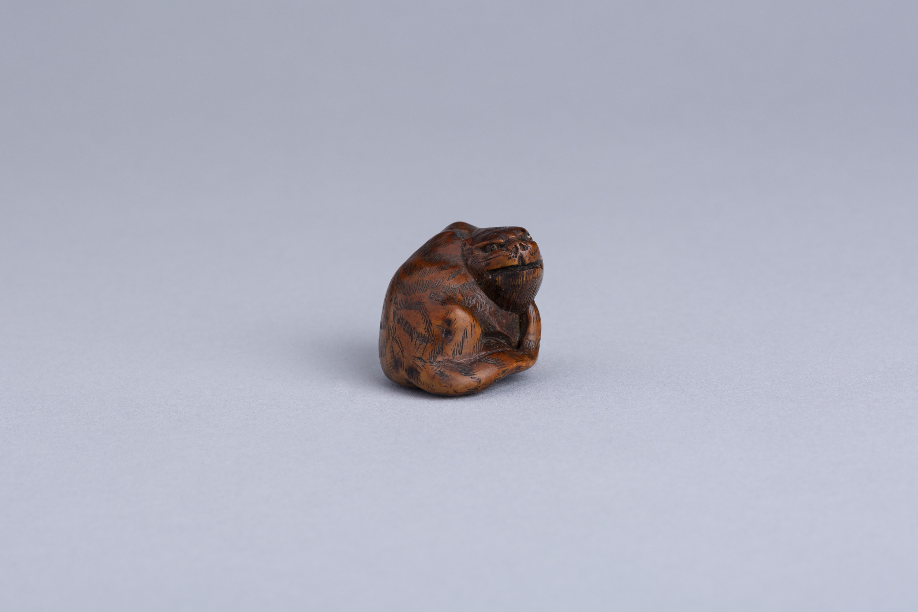 Lot 333 - MASANAO: A WOOD NETSUKE OF A SNARLING TIGER,