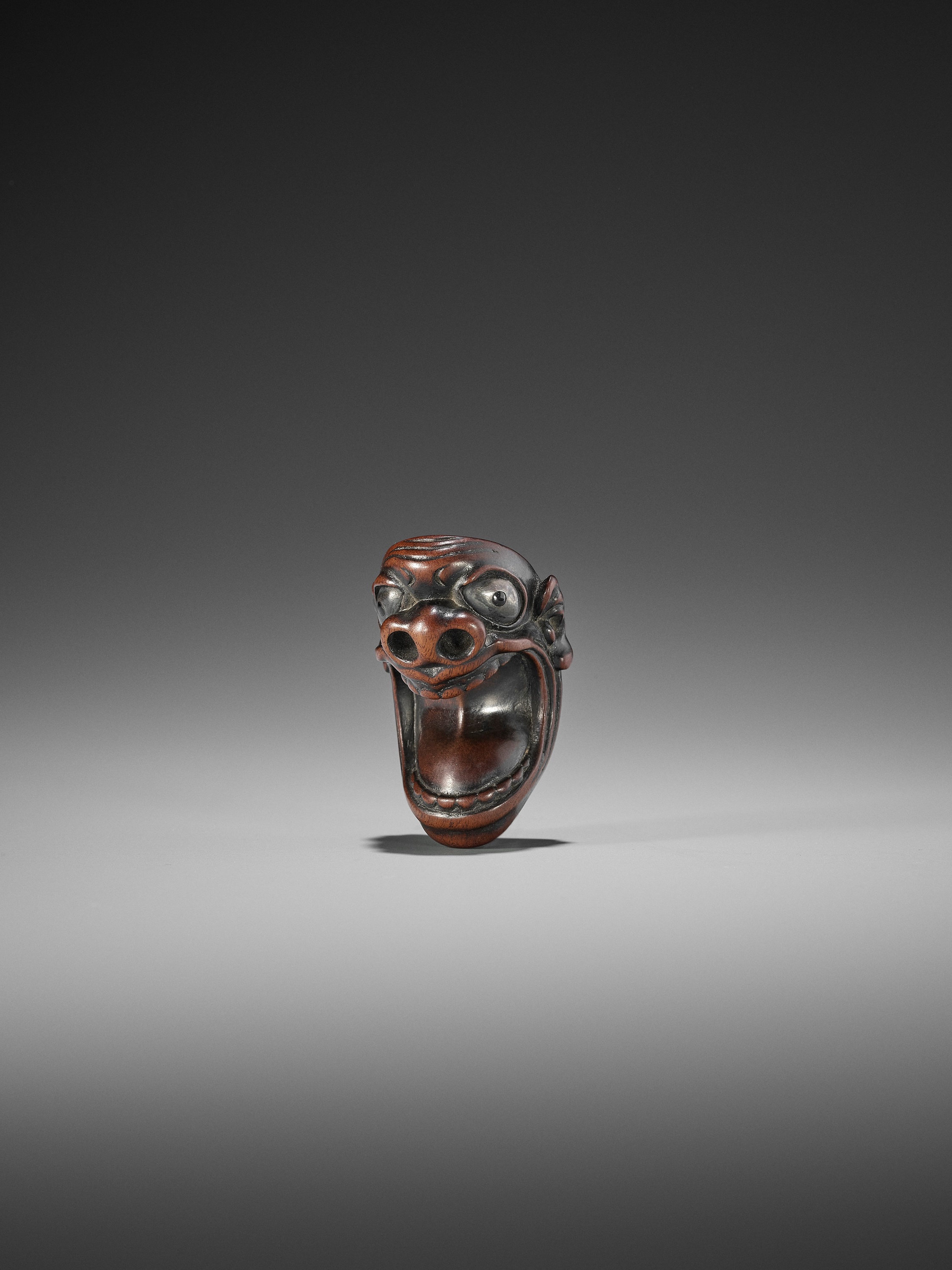 Lot 90 - HOGEN: A RARE WOOD MASK NETSUKE