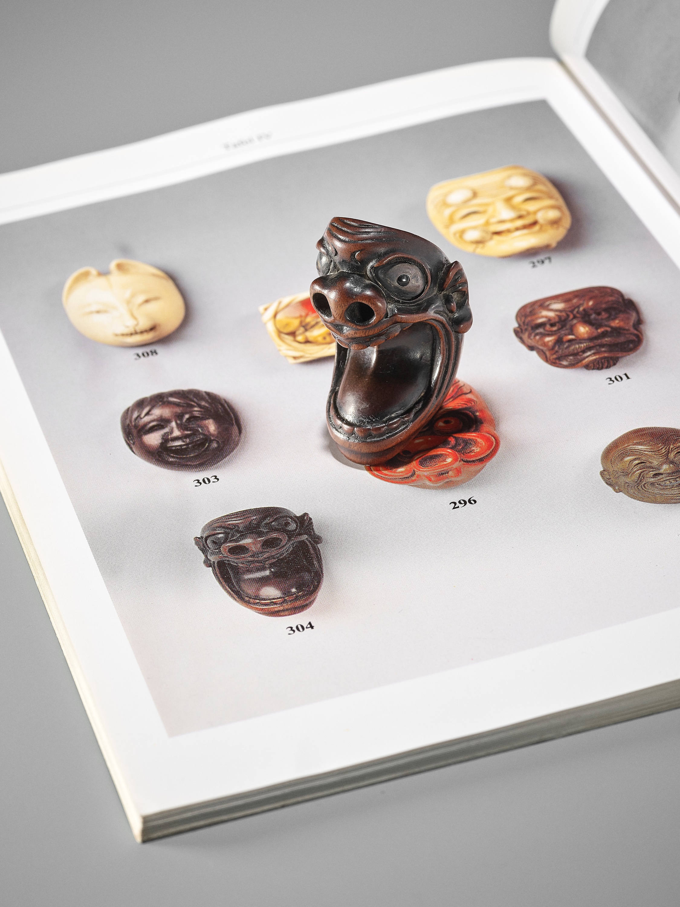 Lot 90 - HOGEN: A RARE WOOD MASK NETSUKE