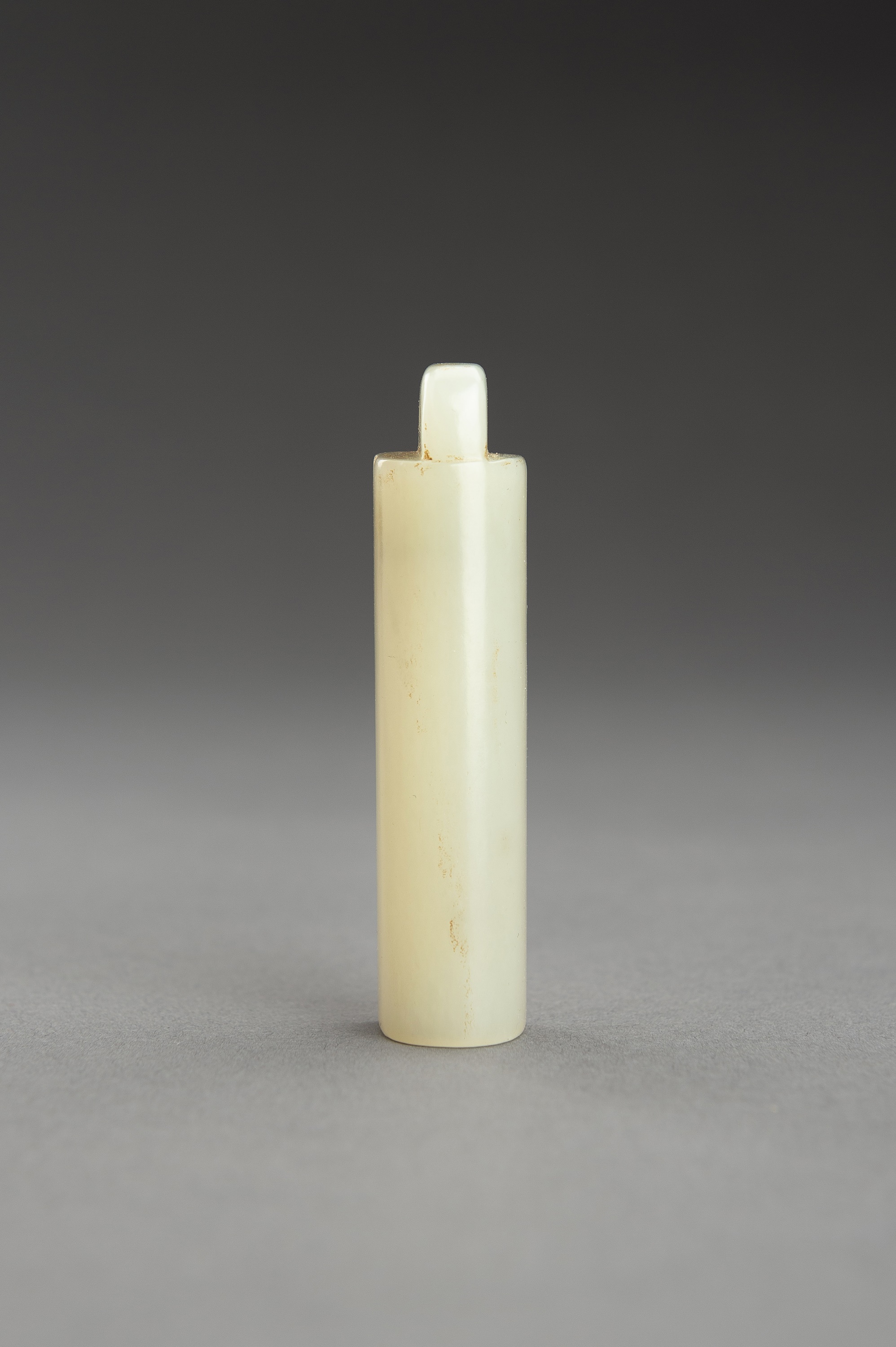 Lot 180 - A PALE CELADON AND RUSSET JADE PLUME HOLDER