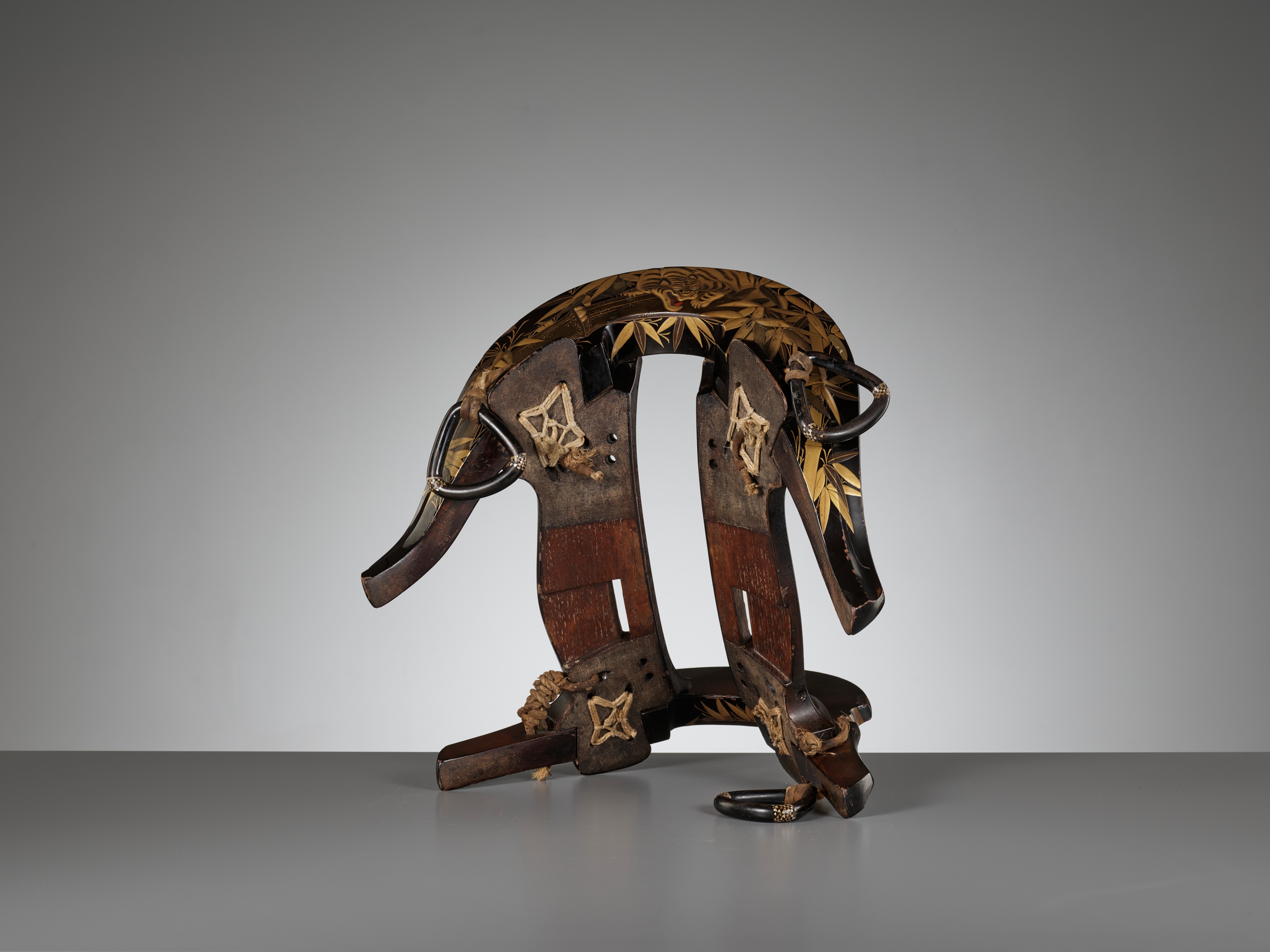 Lot 1311 - A LACQUERED WOOD KURA (SADDLE) WITH TIGERS