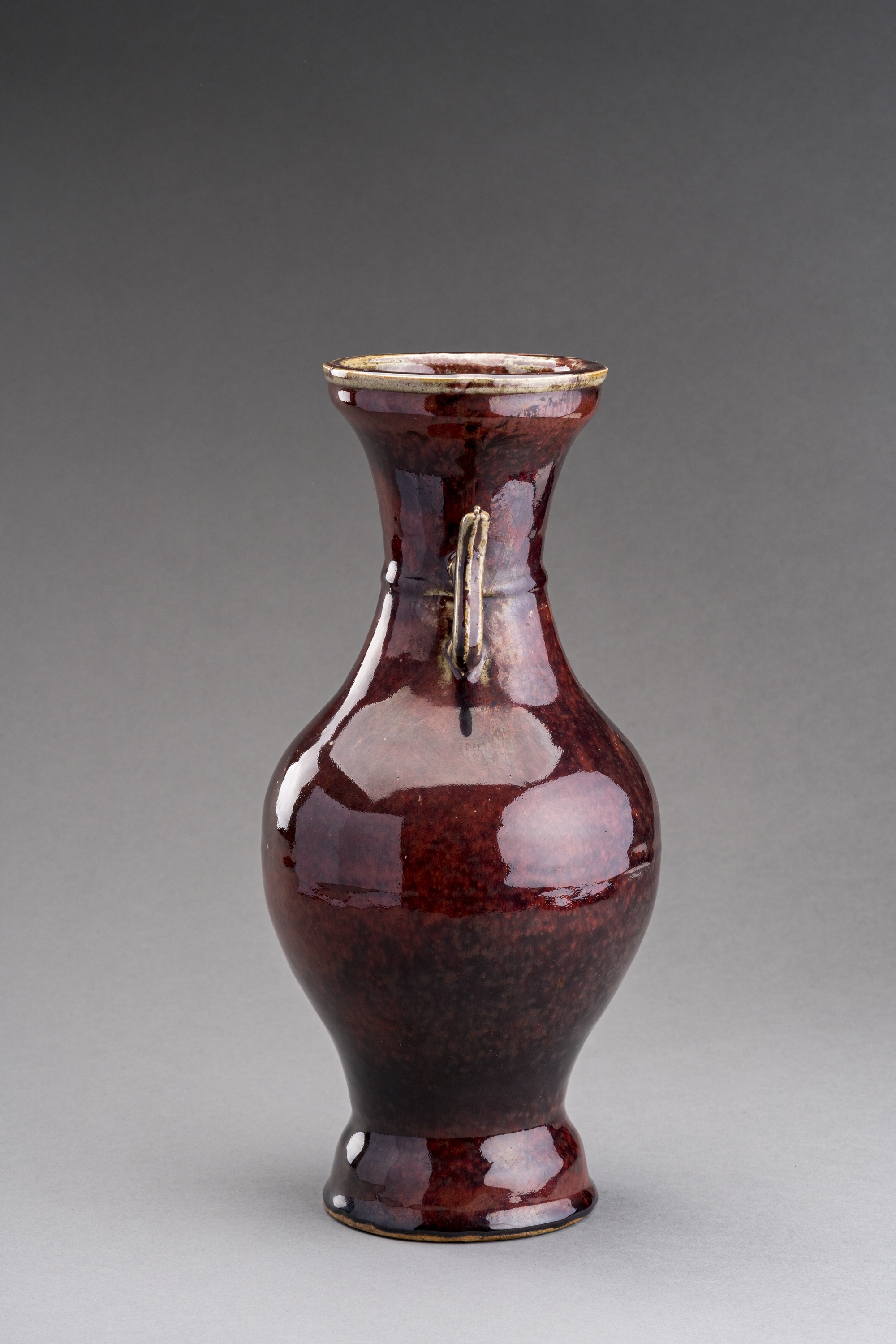 Lot 598 - A RUBY-RED GLAZED SHIWAN CERAMIC VASE, QING