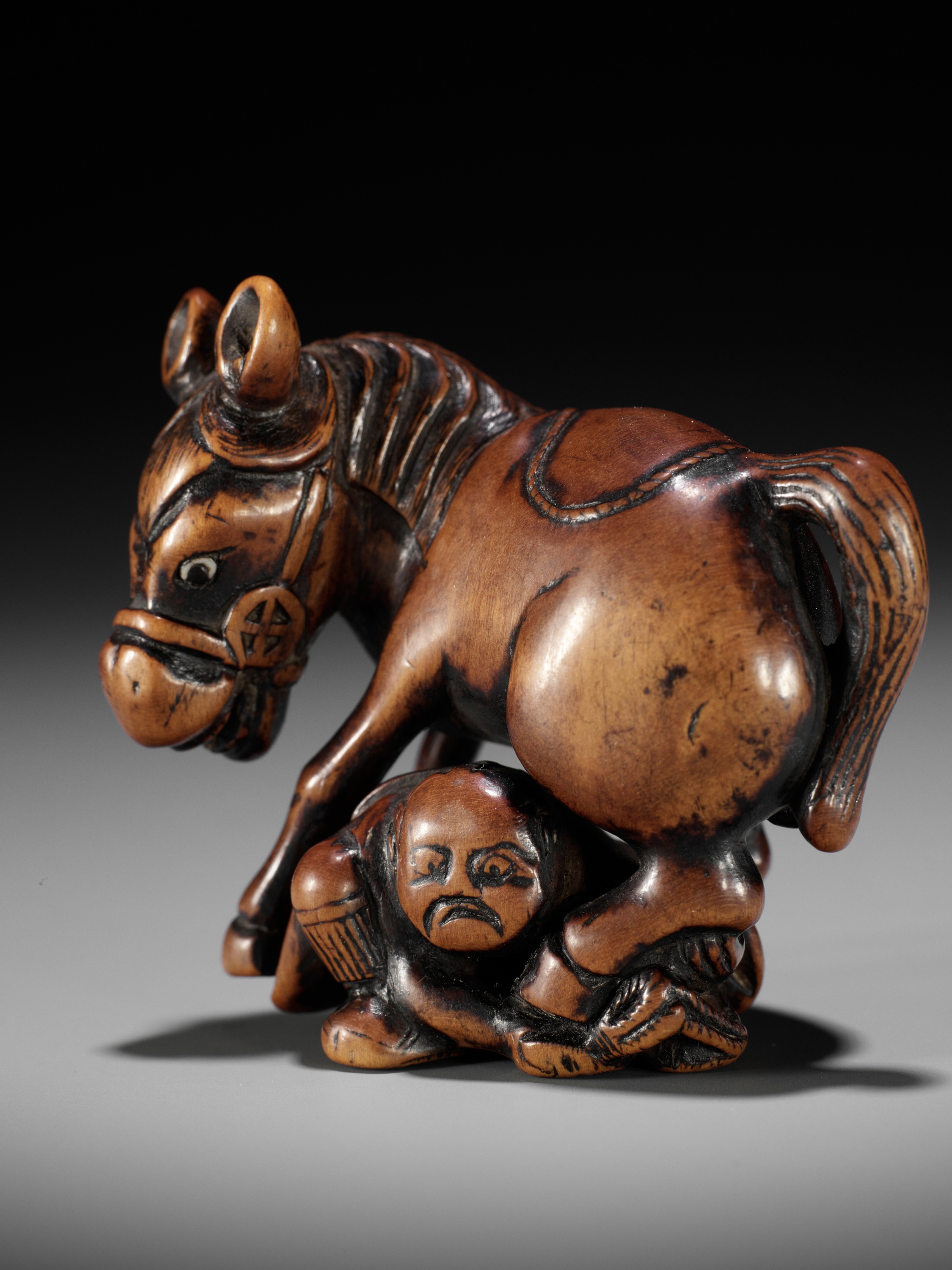 Lot 23 - A SUPERB WOOD NETSUKE OF A MULE AND GROOM