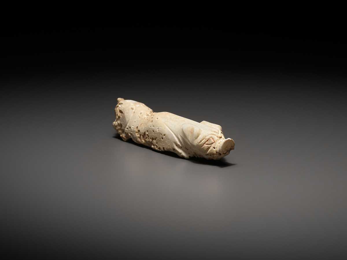 Lot 75 - A WHITE JADE FIGURE OF A PIG, HAN DYNASTY