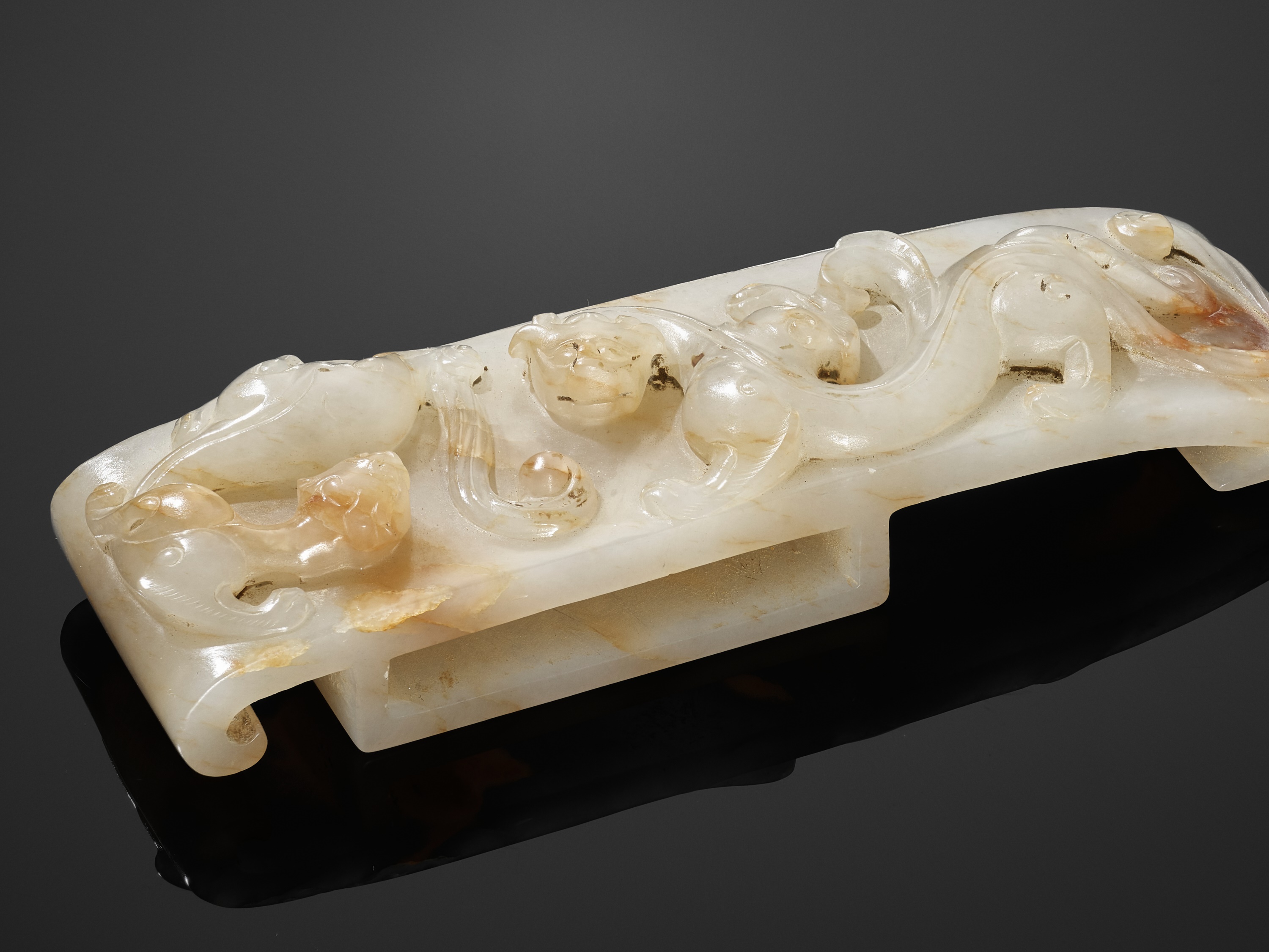 Lot 78 - A 4-PART WHITE AND RUSSET JADE SWORD FITTING,