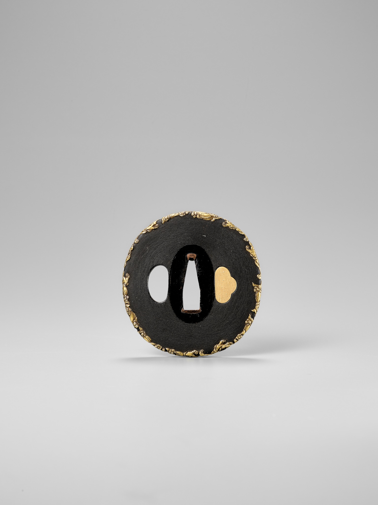 Lot 78 - A FINE GOTO SCHOOL SHAKUDO AND GOLD TSUBA