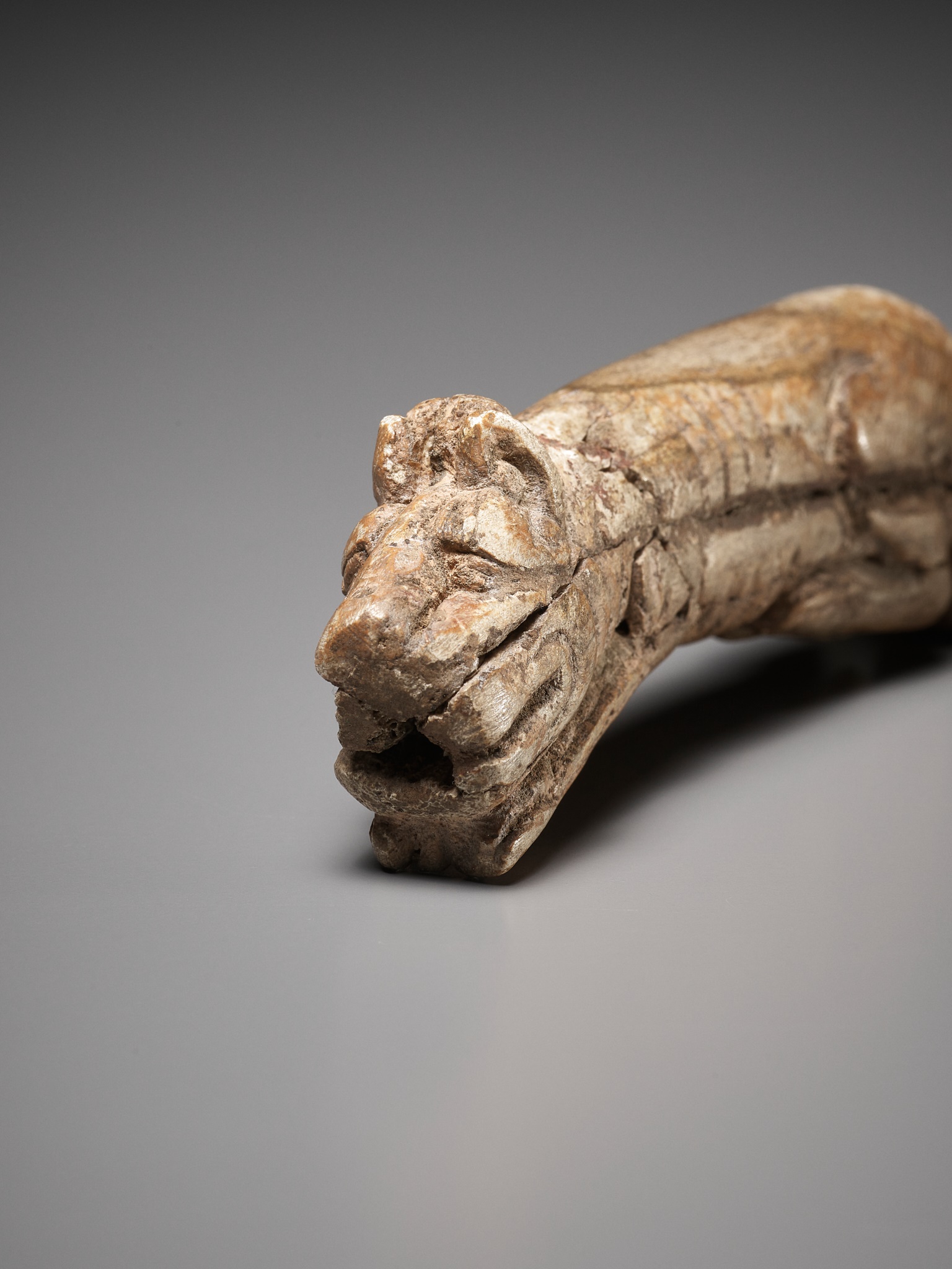 Lot 45 - A RARE CARVED BONE FIGURE OF A TIGER, SHANG