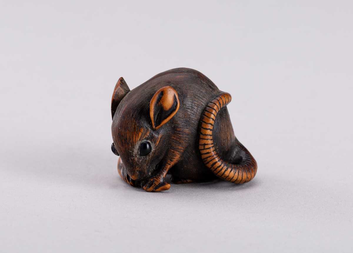 Lot 696 - AFTER TOMOTADA: A WOOD NETSUKE OF A RAT WITH