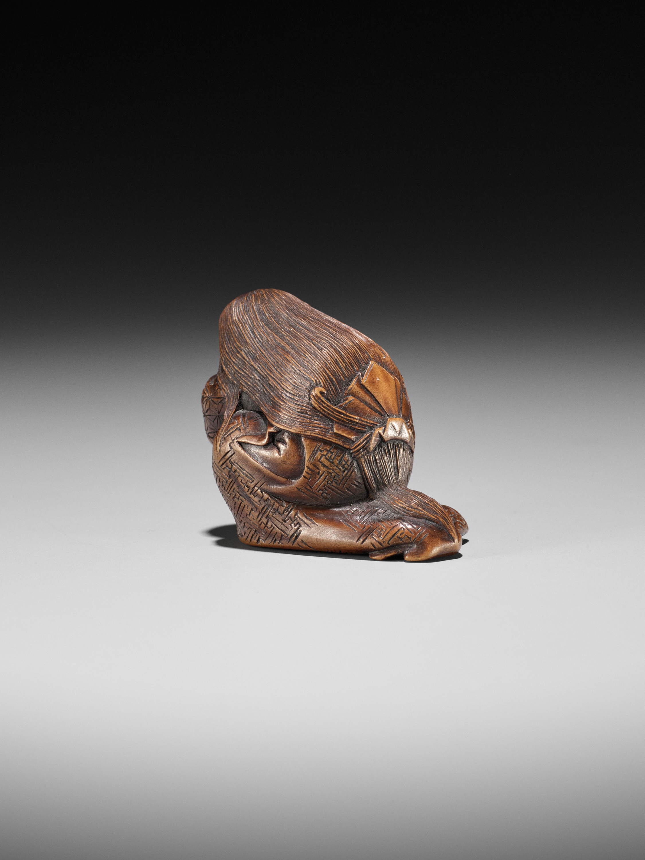 Lot 116 - NOBUKAZU: A WOOD SHUNGA NETSUKE OF OKAME