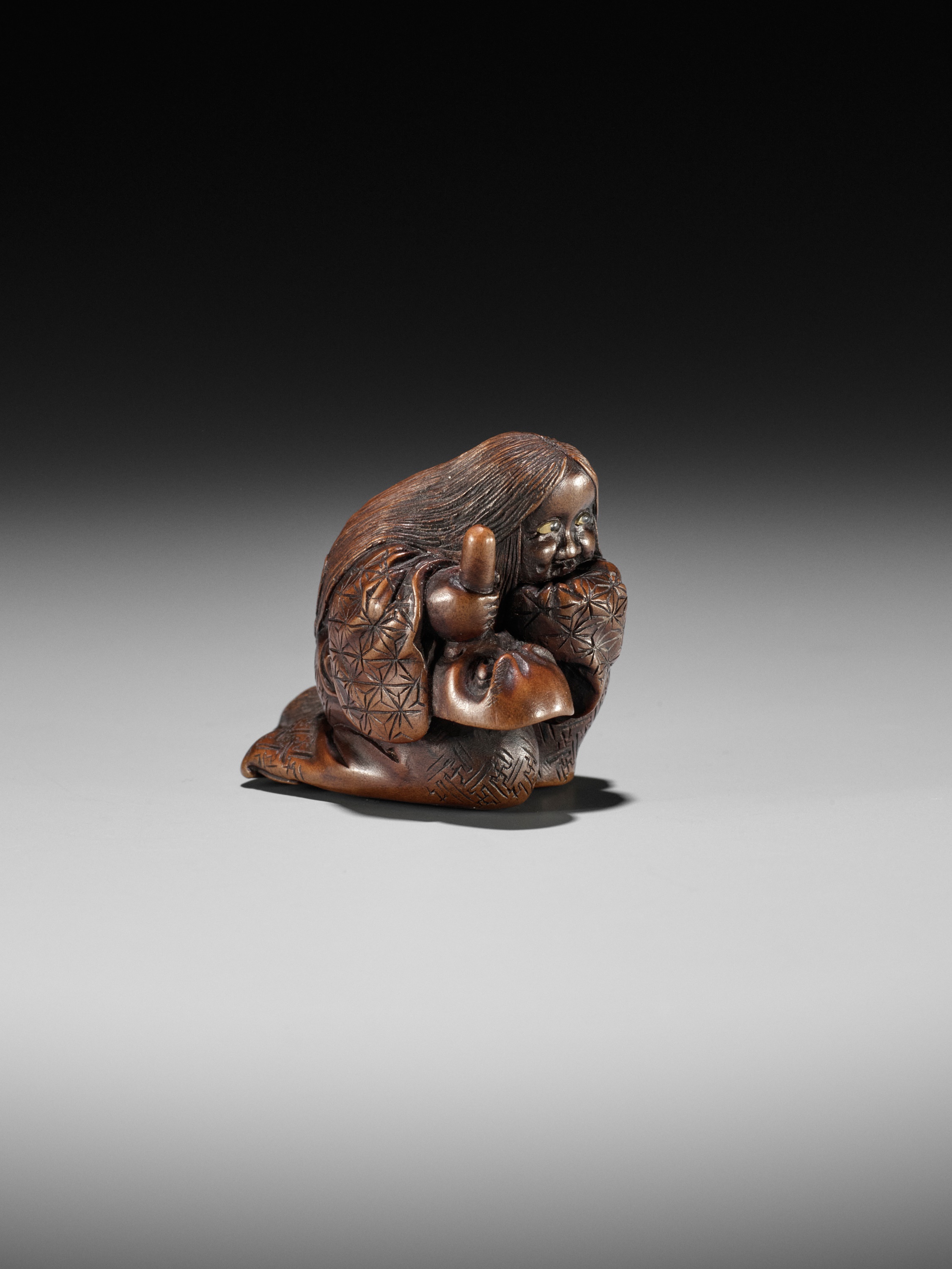 Lot 116 - NOBUKAZU: A WOOD SHUNGA NETSUKE OF OKAME