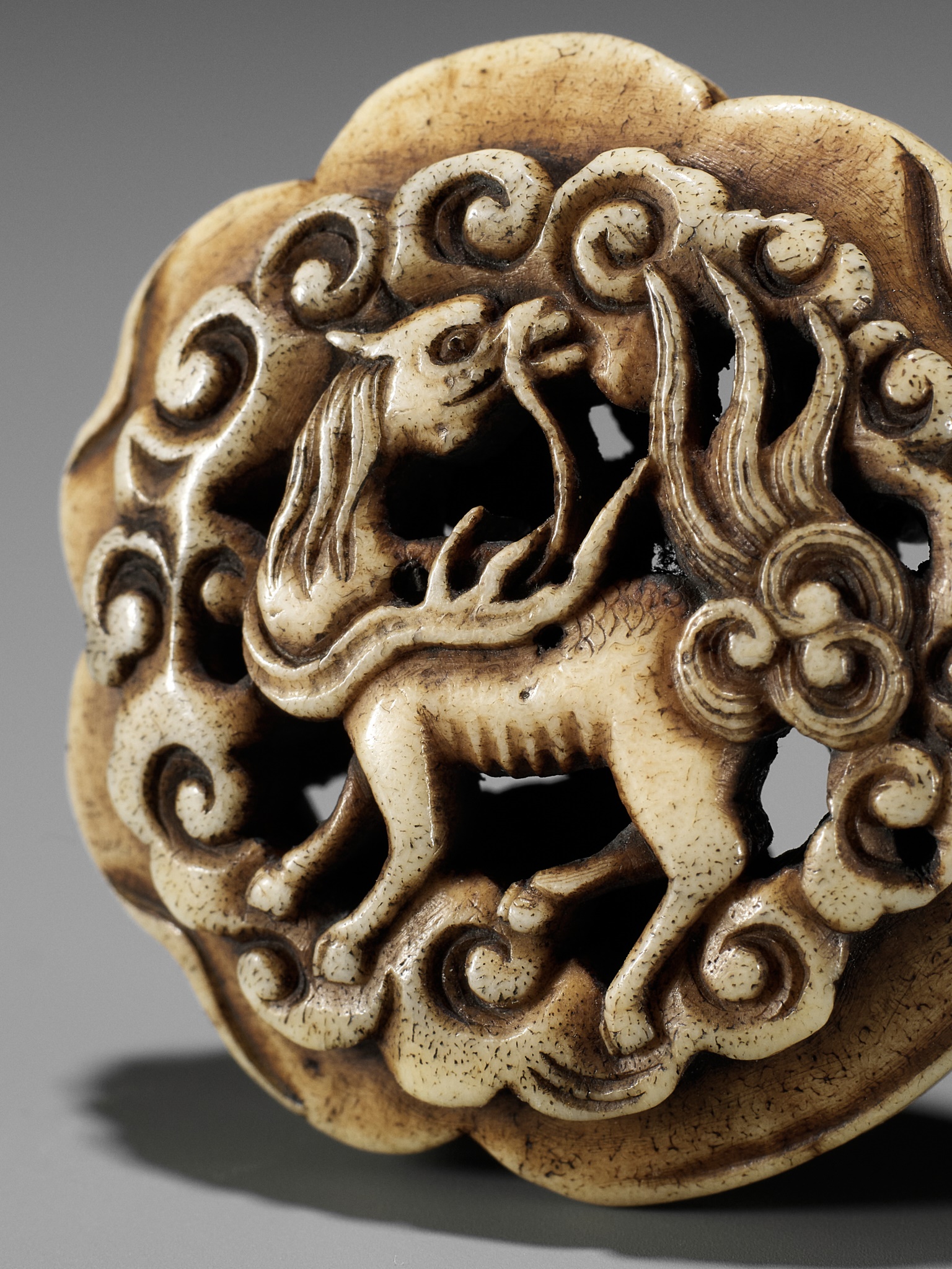 Lot 225 - A STAG ANTLER RYUSA MANJU NETSUKE OF A KIRIN