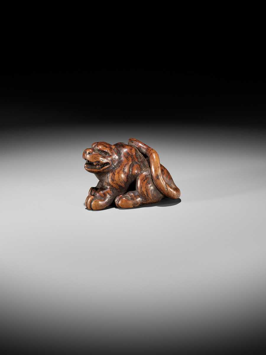 Lot 141 - KOKEI: A WOOD NETSUKE OF A TIGER