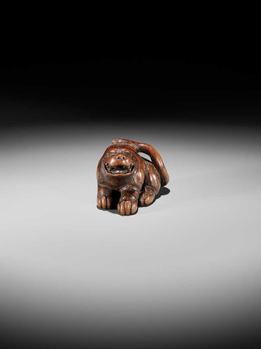 Lot 141 - KOKEI: A WOOD NETSUKE OF A TIGER