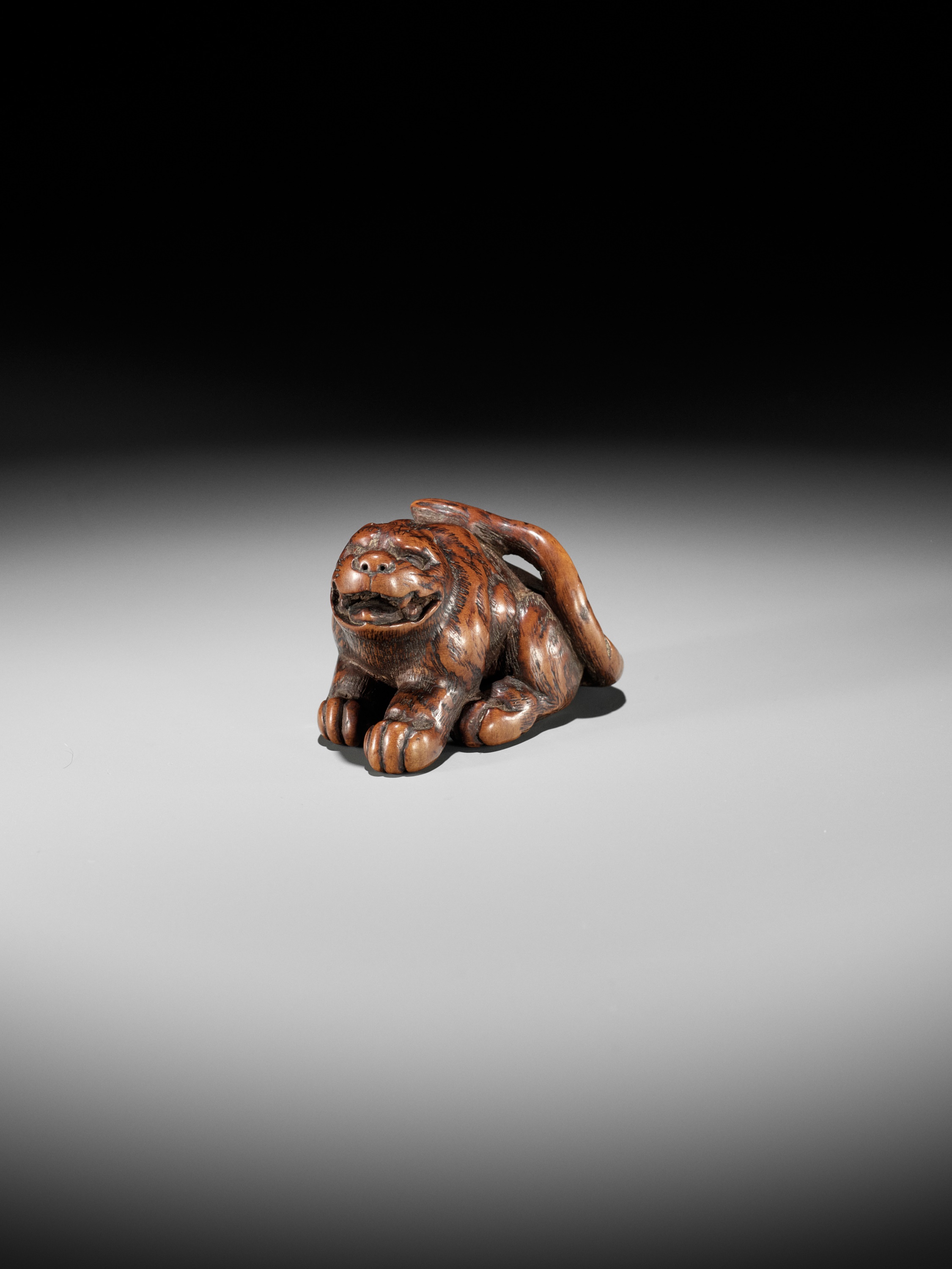 Lot 141 - KOKEI: A WOOD NETSUKE OF A TIGER