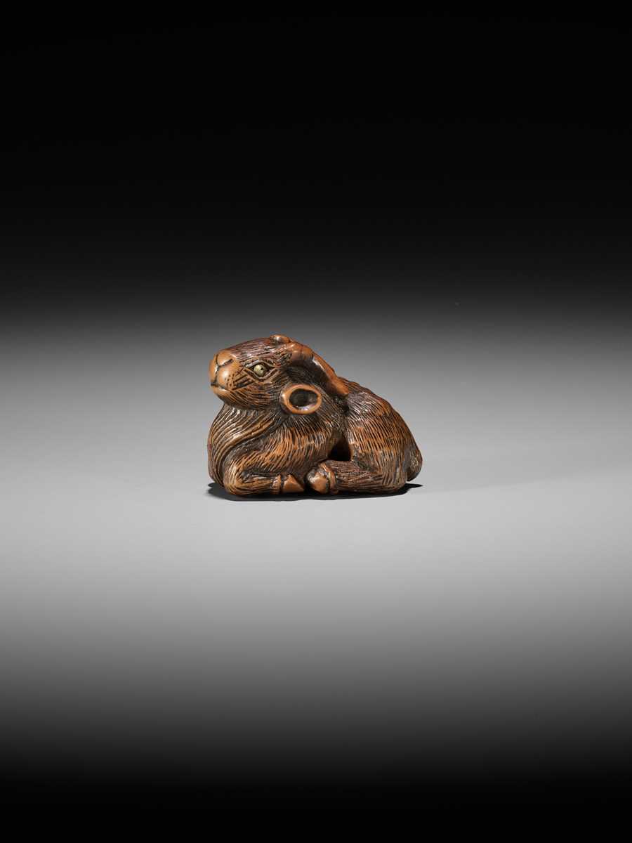 Lot 137 - MINKO: A WOOD NETSUKE OF A RECUMBENT GOAT