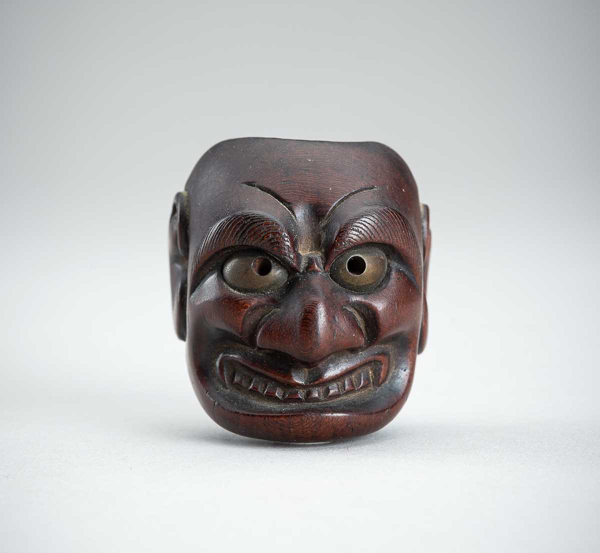Lot 498 - DEME UMAN: A WOOD MASK NETSUKE OF BUAKU, EDO
