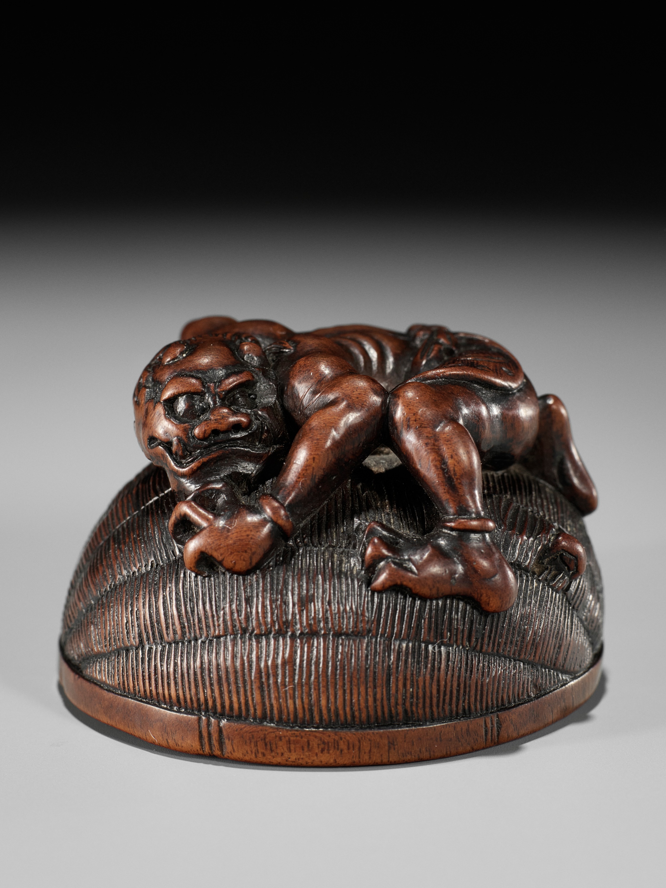 Lot 65 - MASANAO: A RARE WOOD NETSUKE OF AN ONI